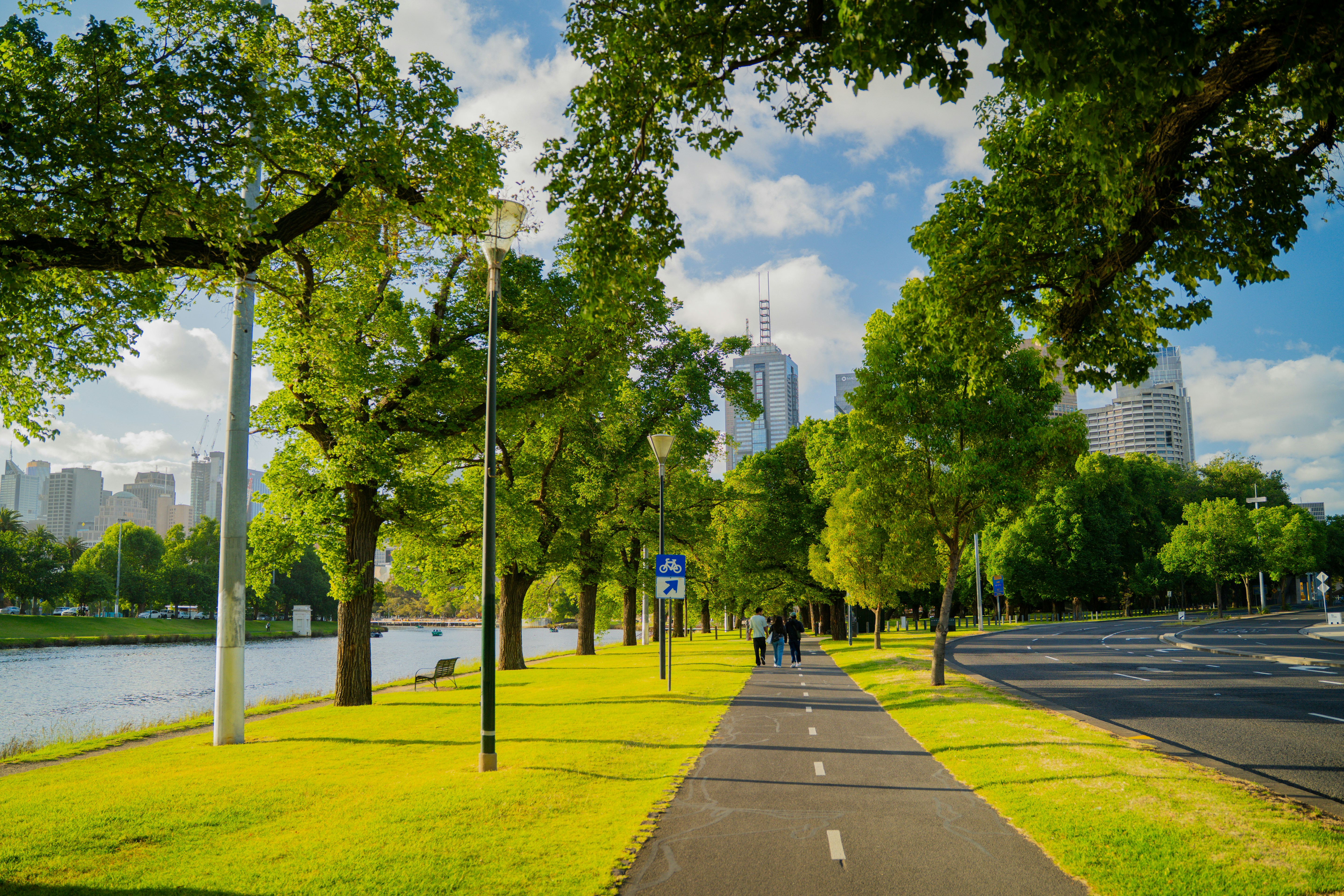 Urban riverside promenade bathed in afternoon light