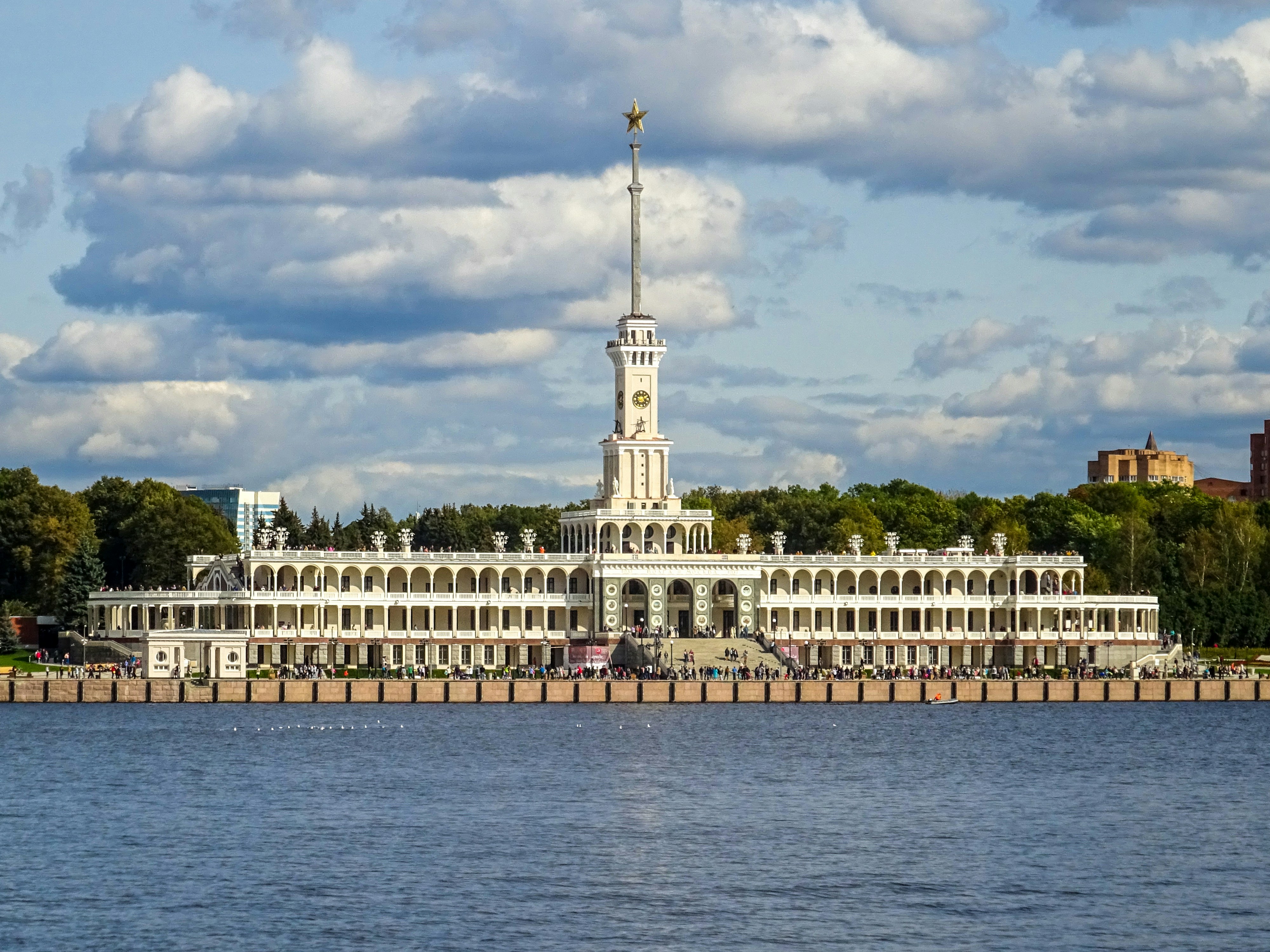 Renaissance Terrace: A Waterfront Pavilioned Monument Under a Sky of Puffs