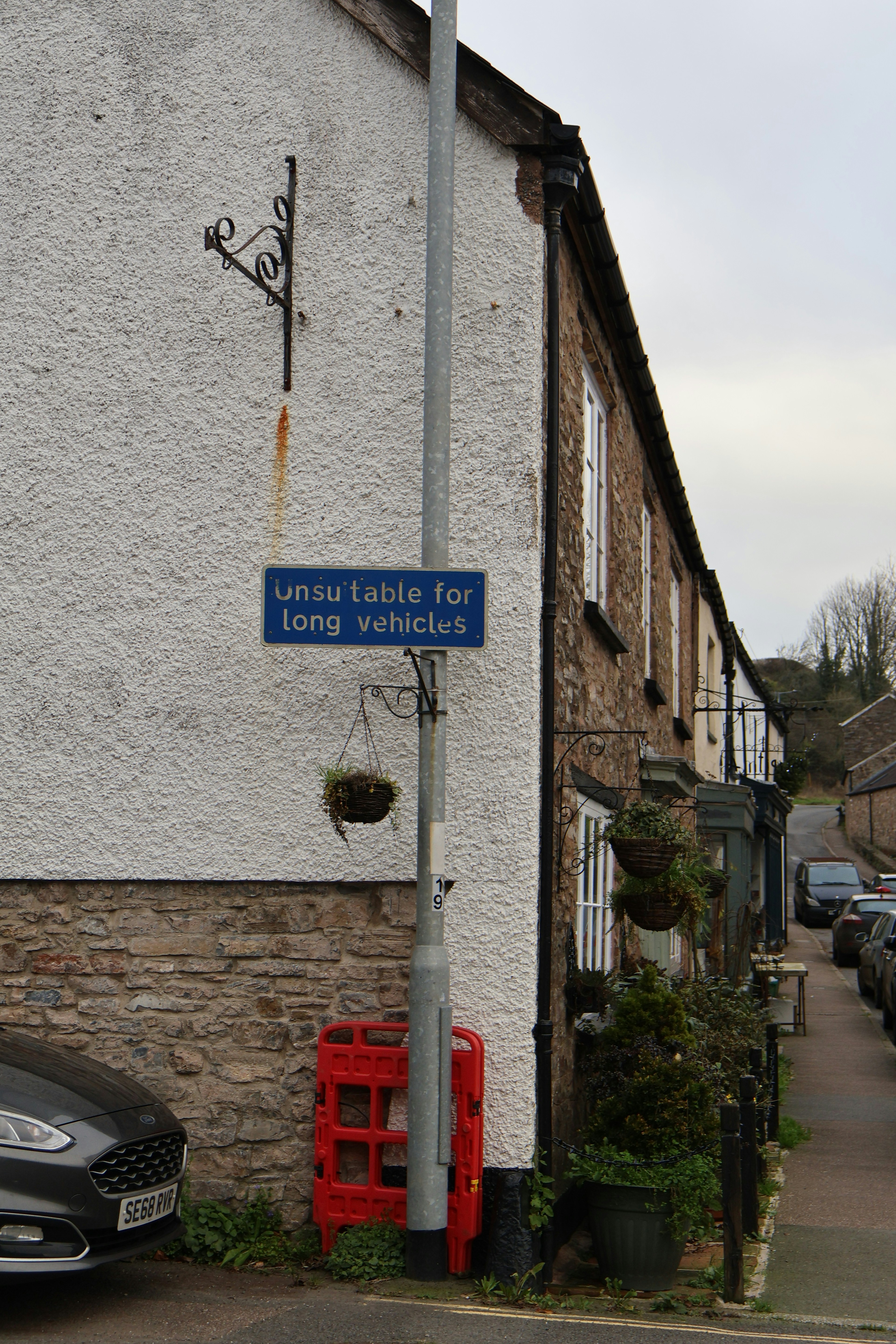 Lane of Details: A Quiet Street Scene Framed by Weathered Facades
