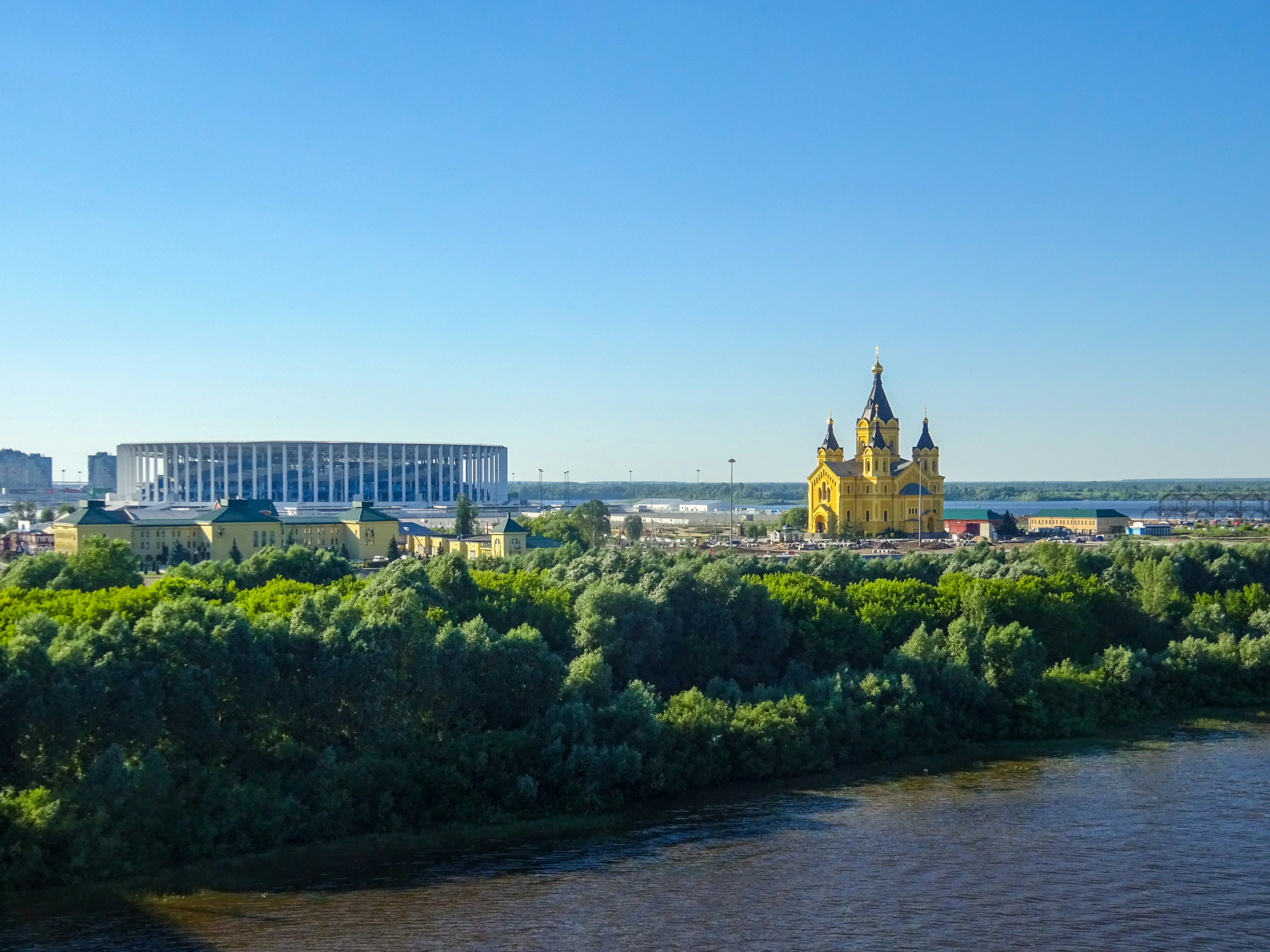 Riverside City Skyline: Golden Dome and Modern Facade Rising Above Green Canopy