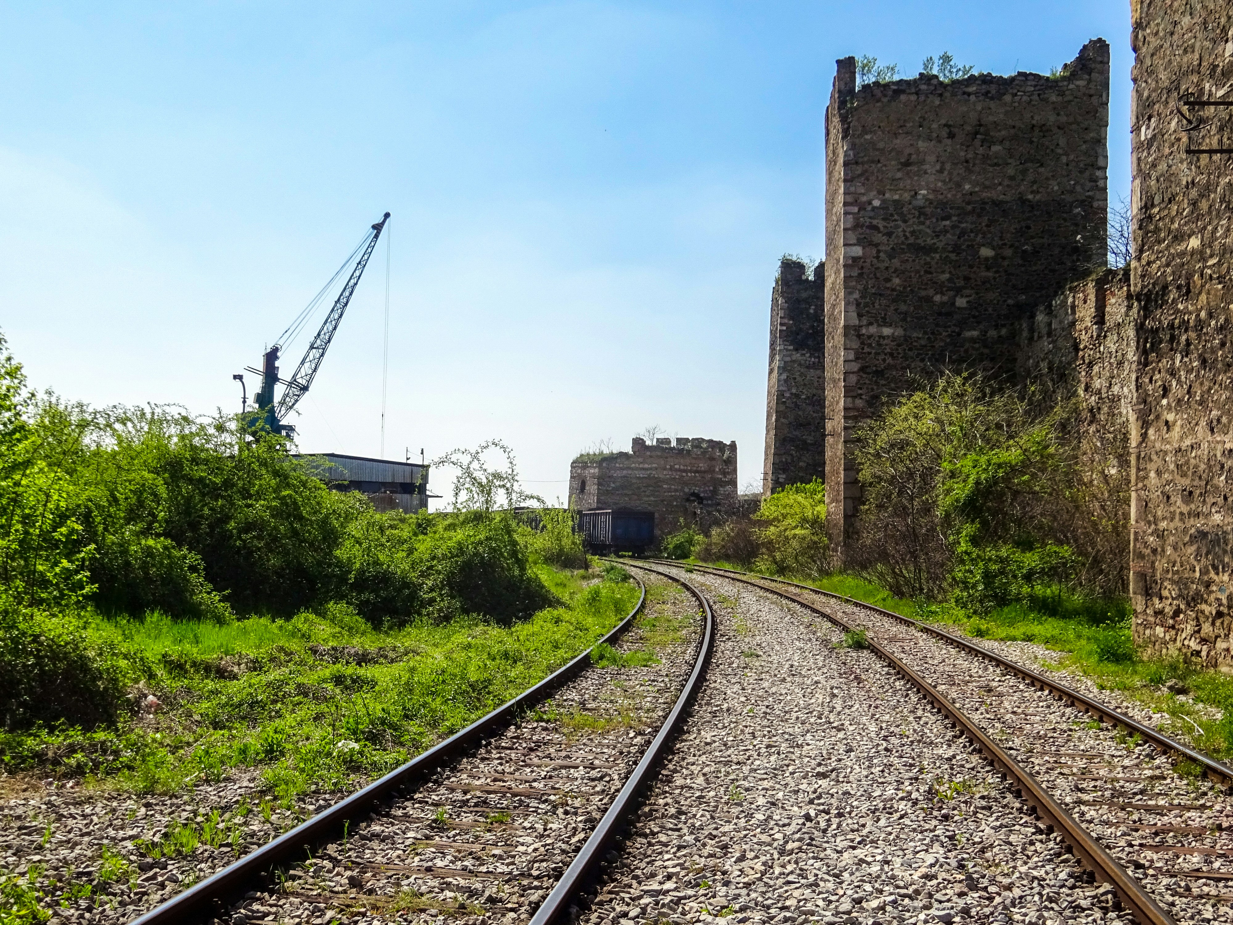 Industrial Rails Toward Ruined Towers