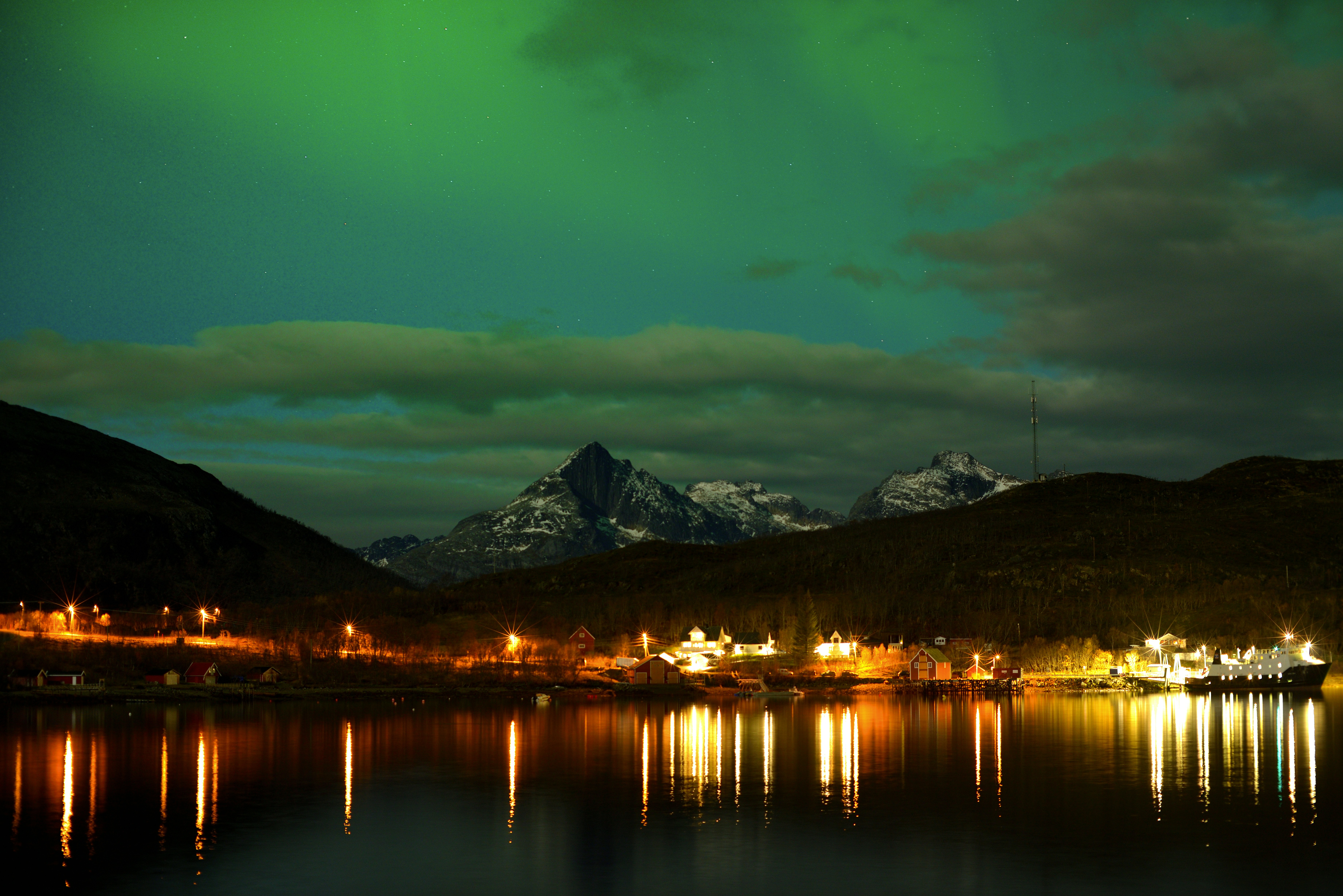 Aurora over a Quiet Fjord: Night Lights Reflecting in Still Waters