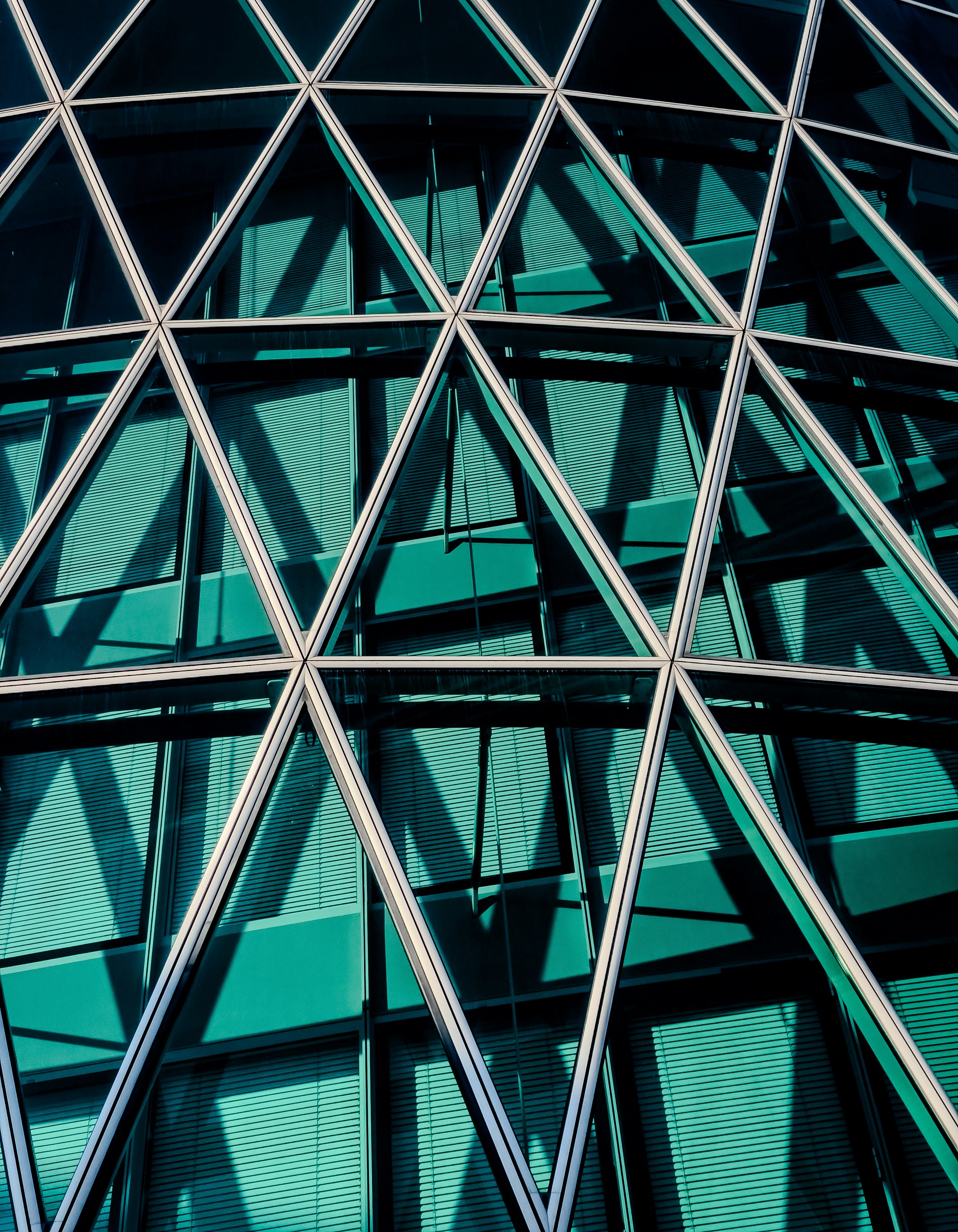 Crisscross of Glass: A Teal Facade’s Geometric Heart