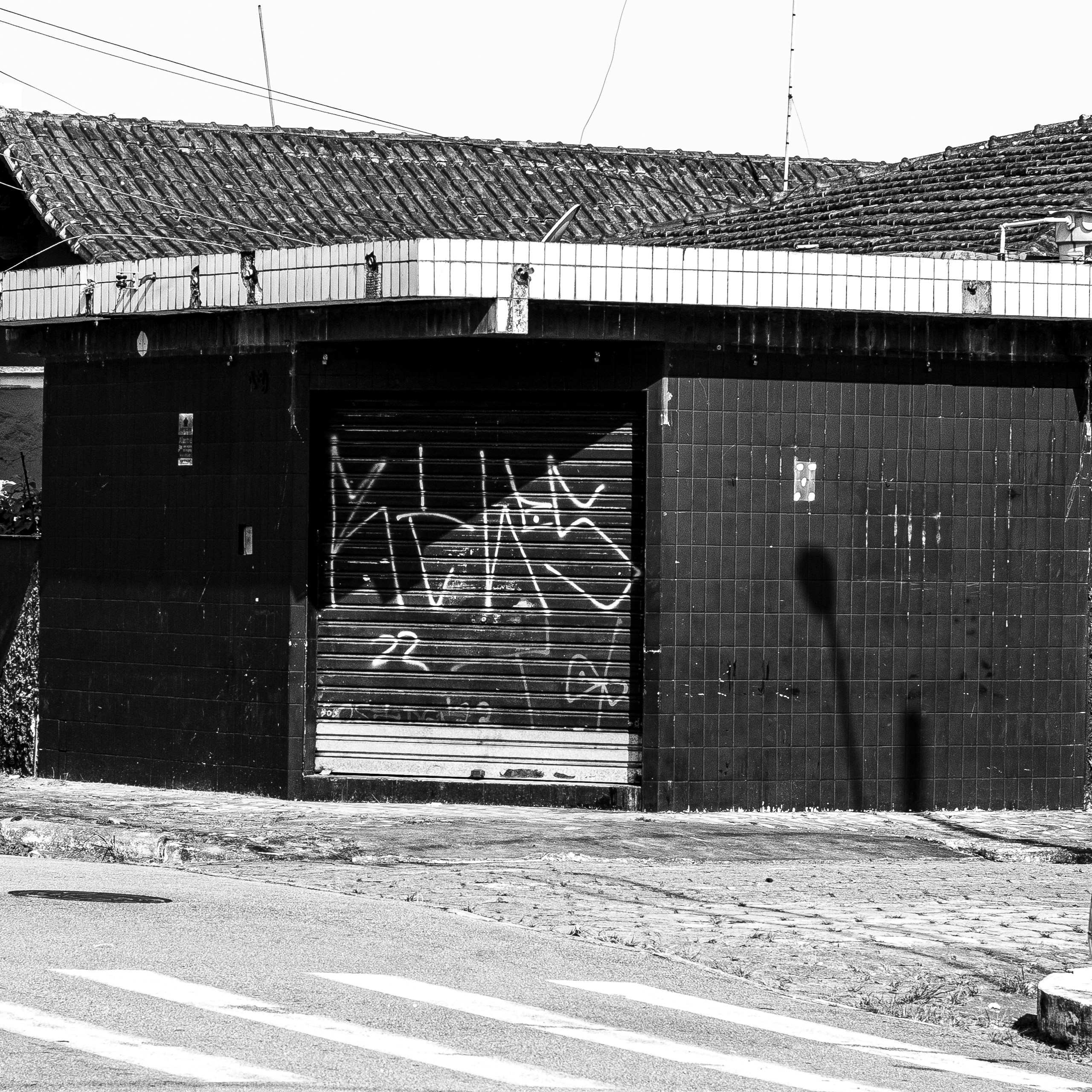 Graffiti on a closed storefront with a tiled facade. photo – Free ...