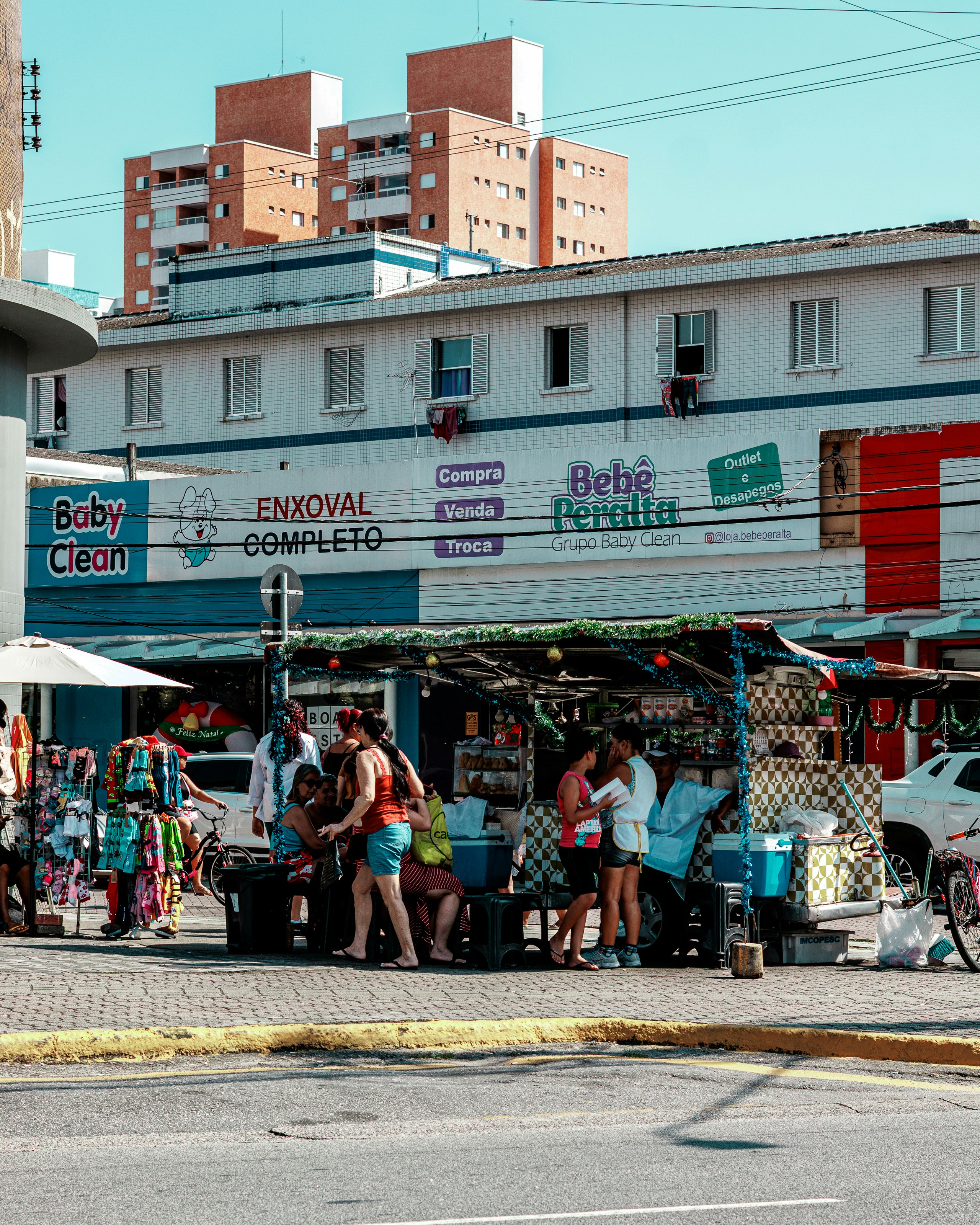 Bustling Street Market beneath a Row of Coral Buildings