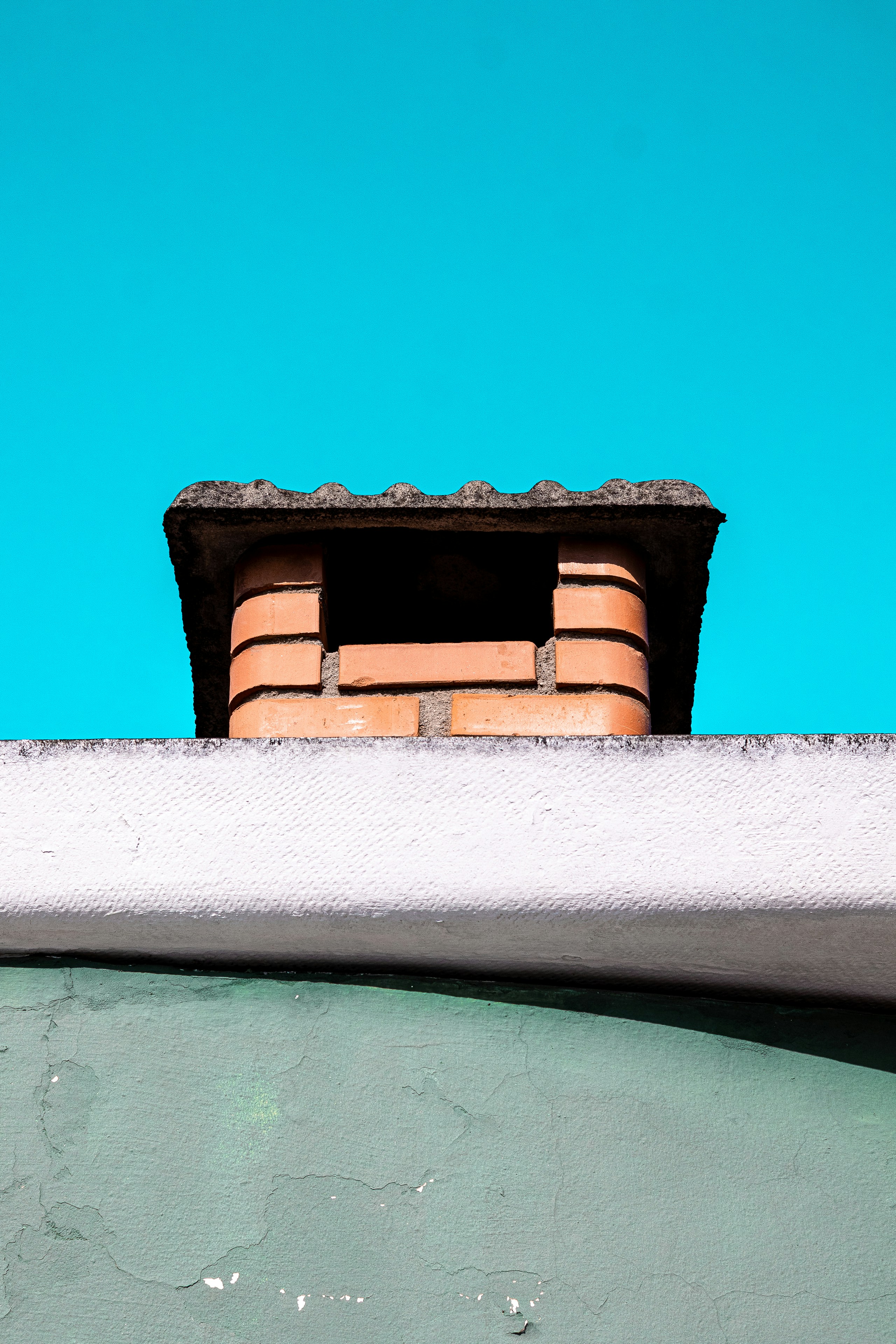Brick Chimney Crown Rising Against a Cerulean Sky
