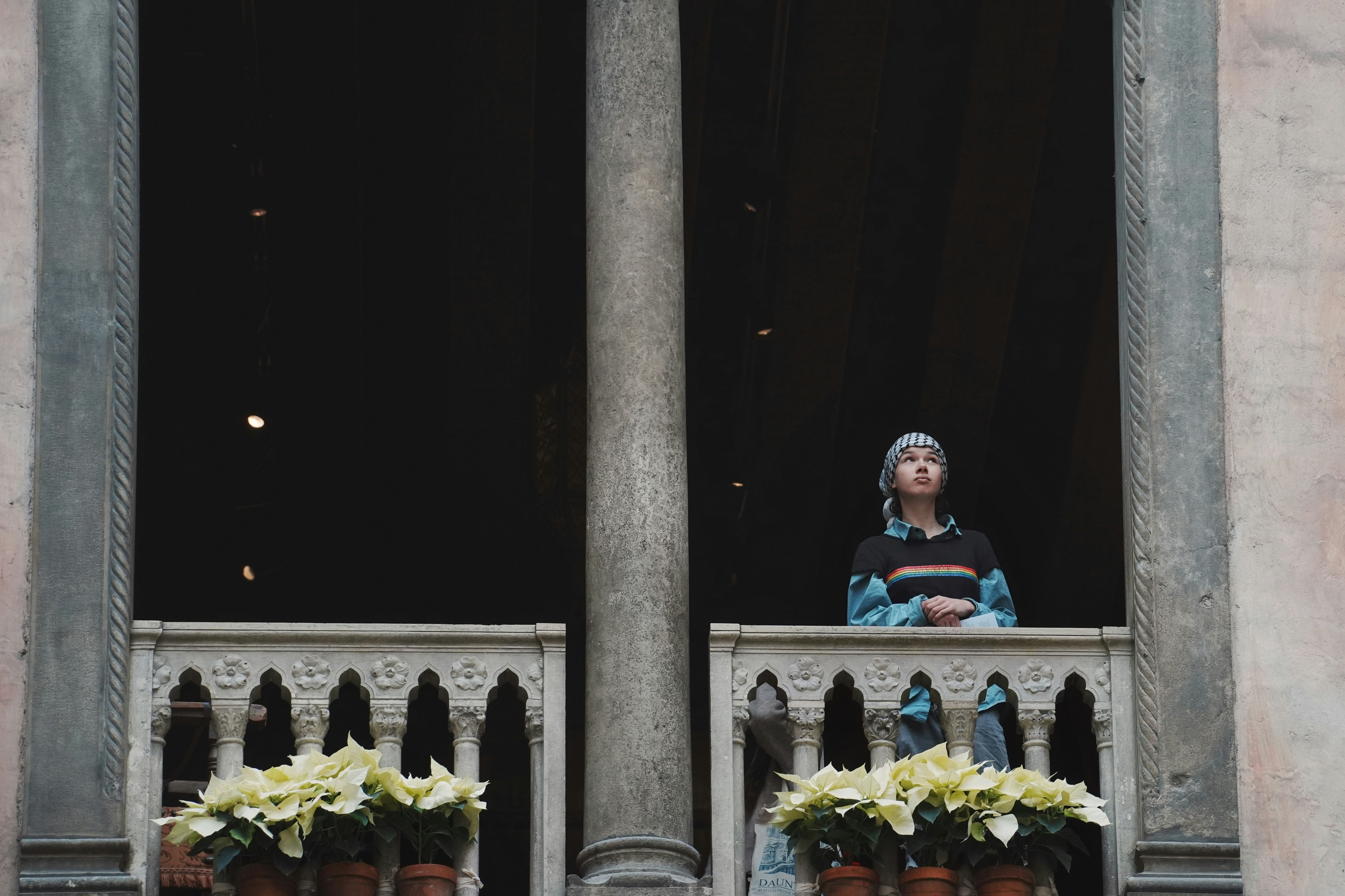Youth on a Balcony: Quiet Vigil by the Columns
