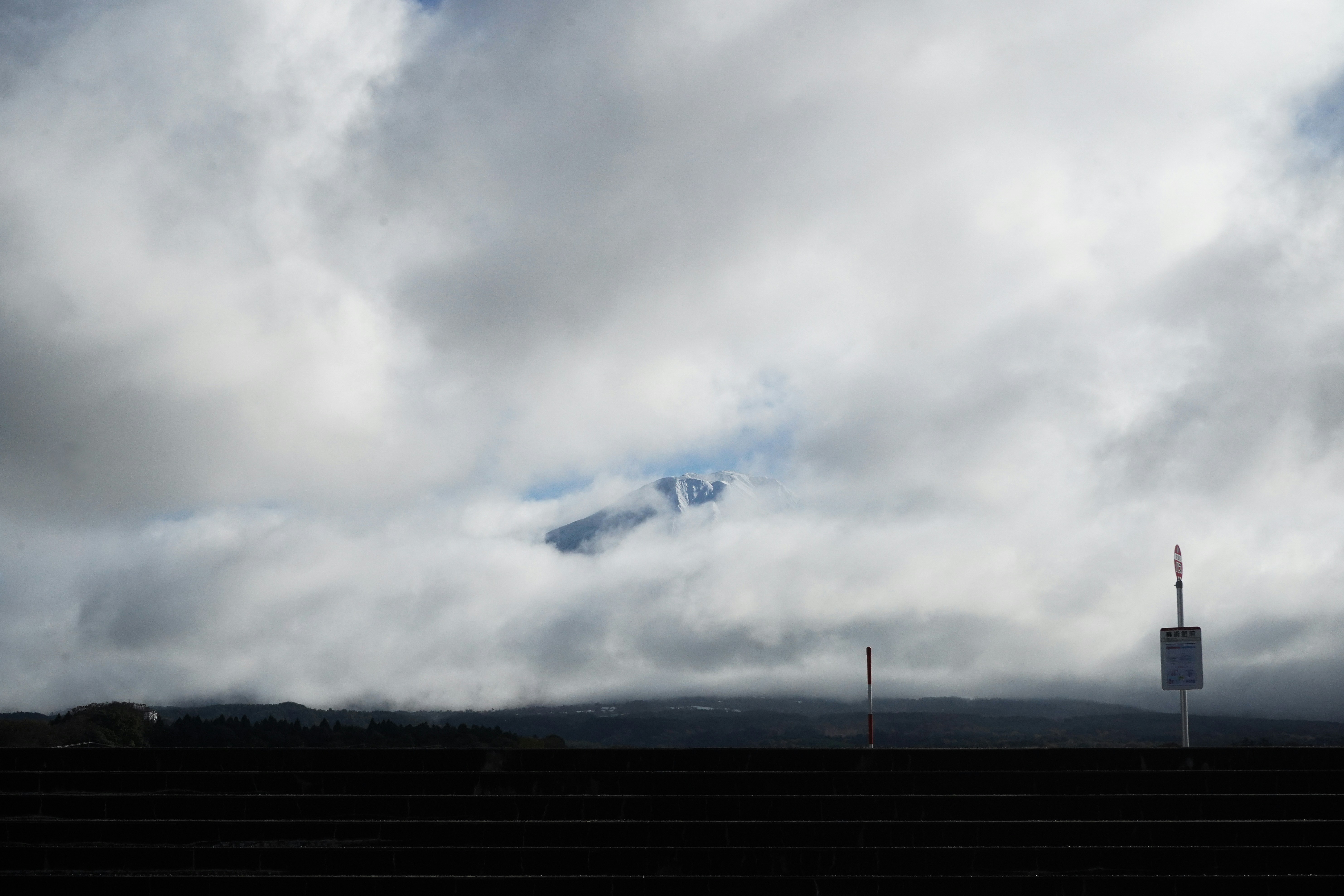Mist over a distant peak: a quiet horizon blocked by clouds