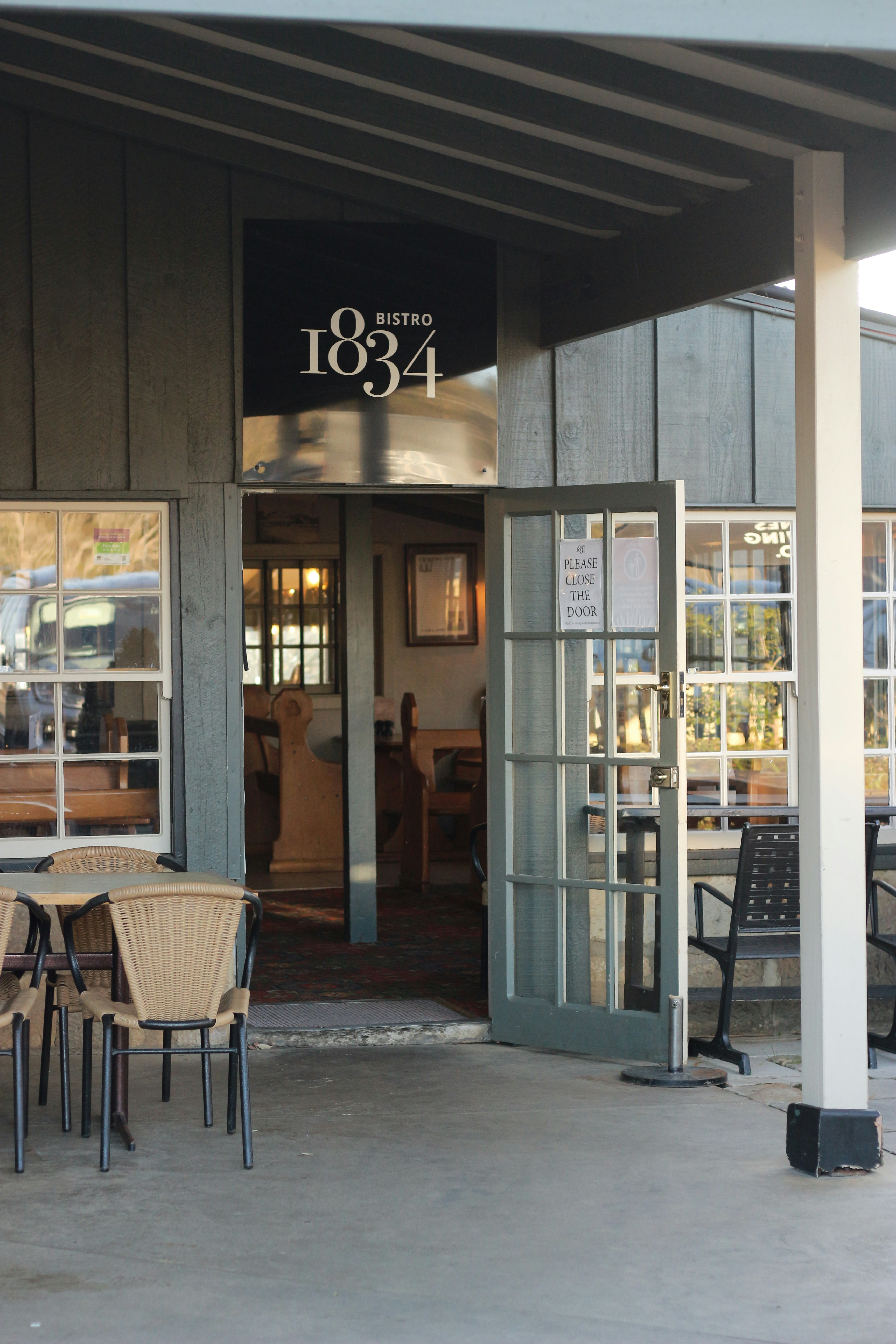 Cafe Entrance at Bistro 1834: Open Doors, Warm Interior