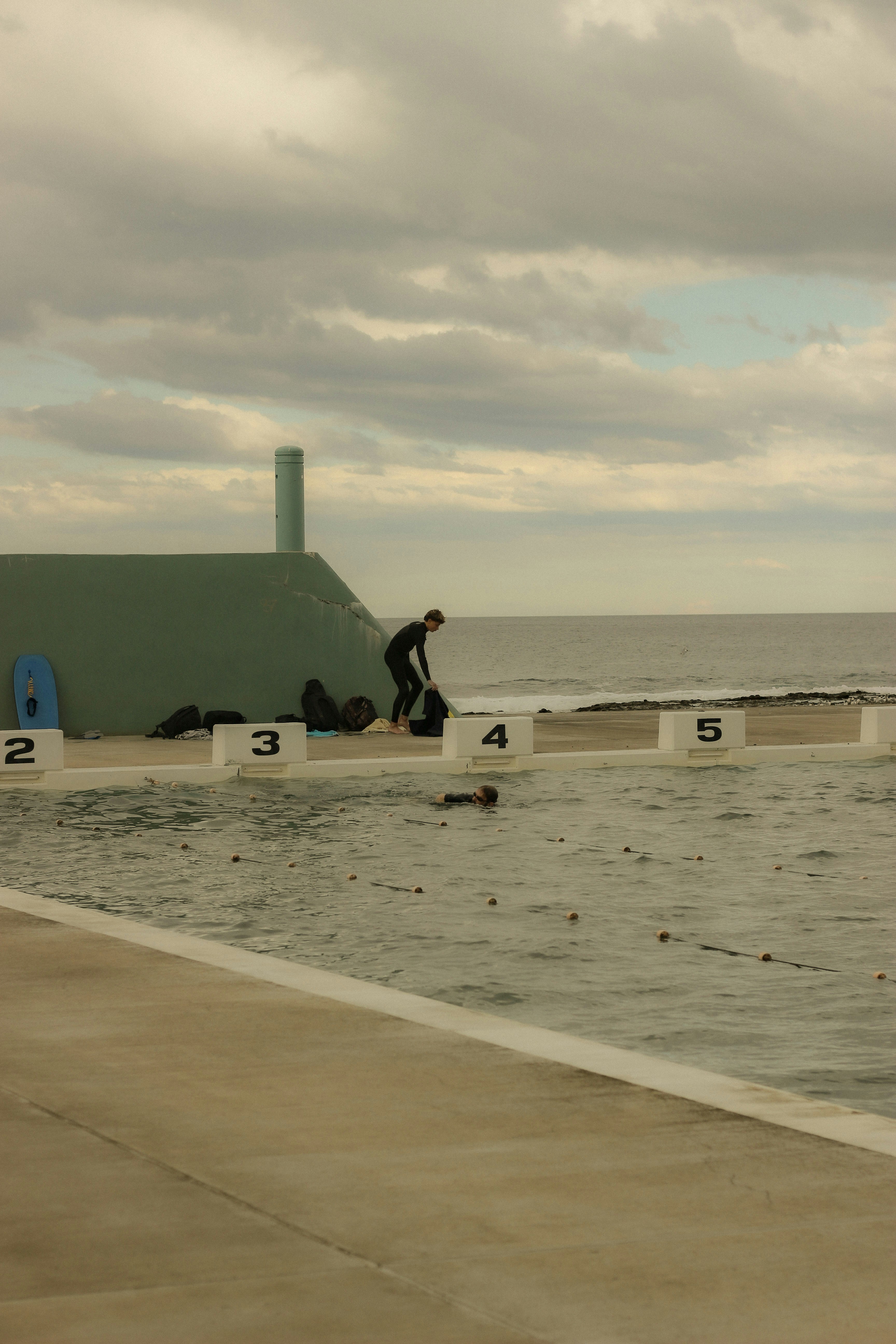 Surfer’s Wait by the Lane: A Runner-Up Moment at the Coastal Pool