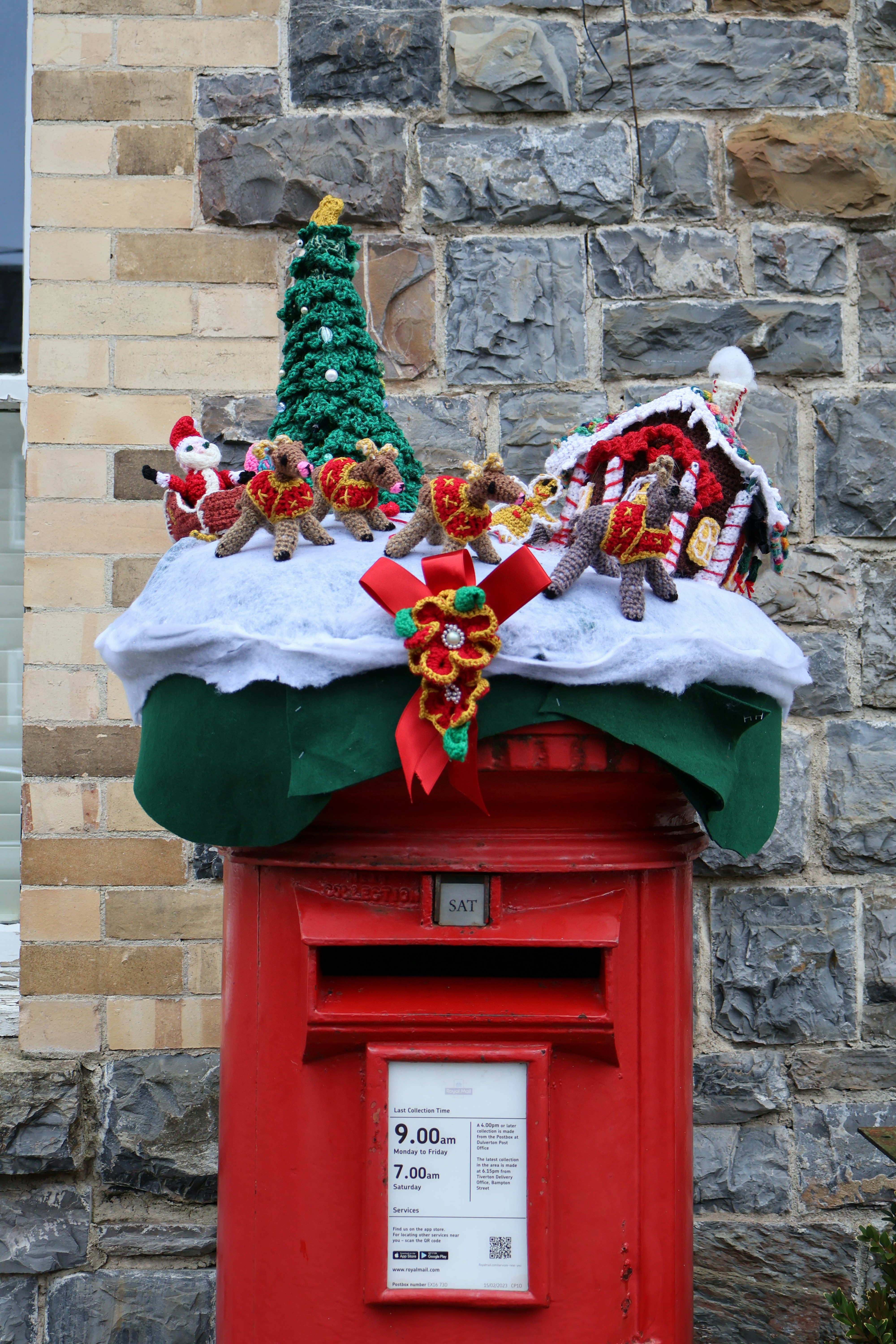 Festive Mailbox Stand Under a Stone Wall