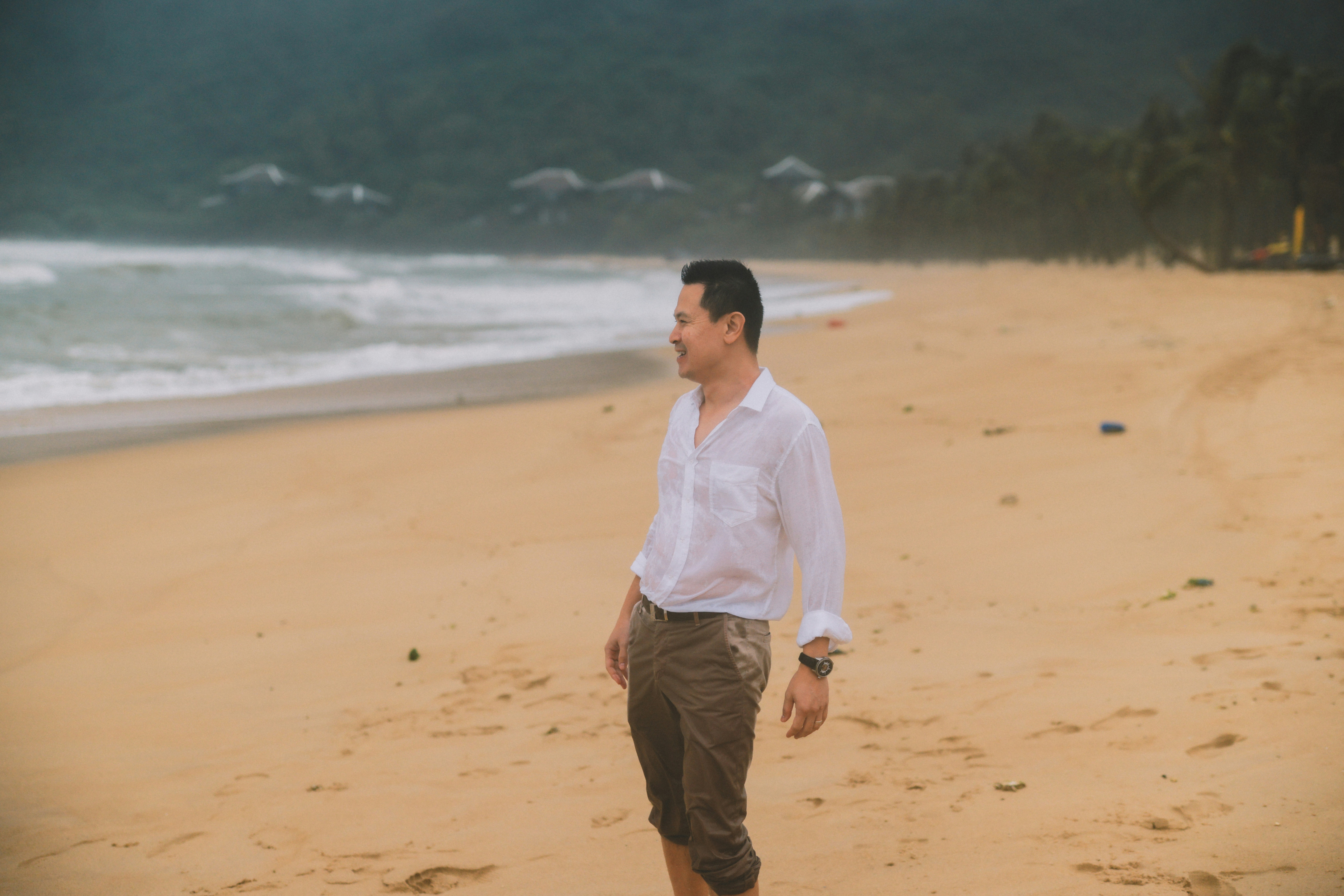 Solitary stroll: a calm man on sunlit beach