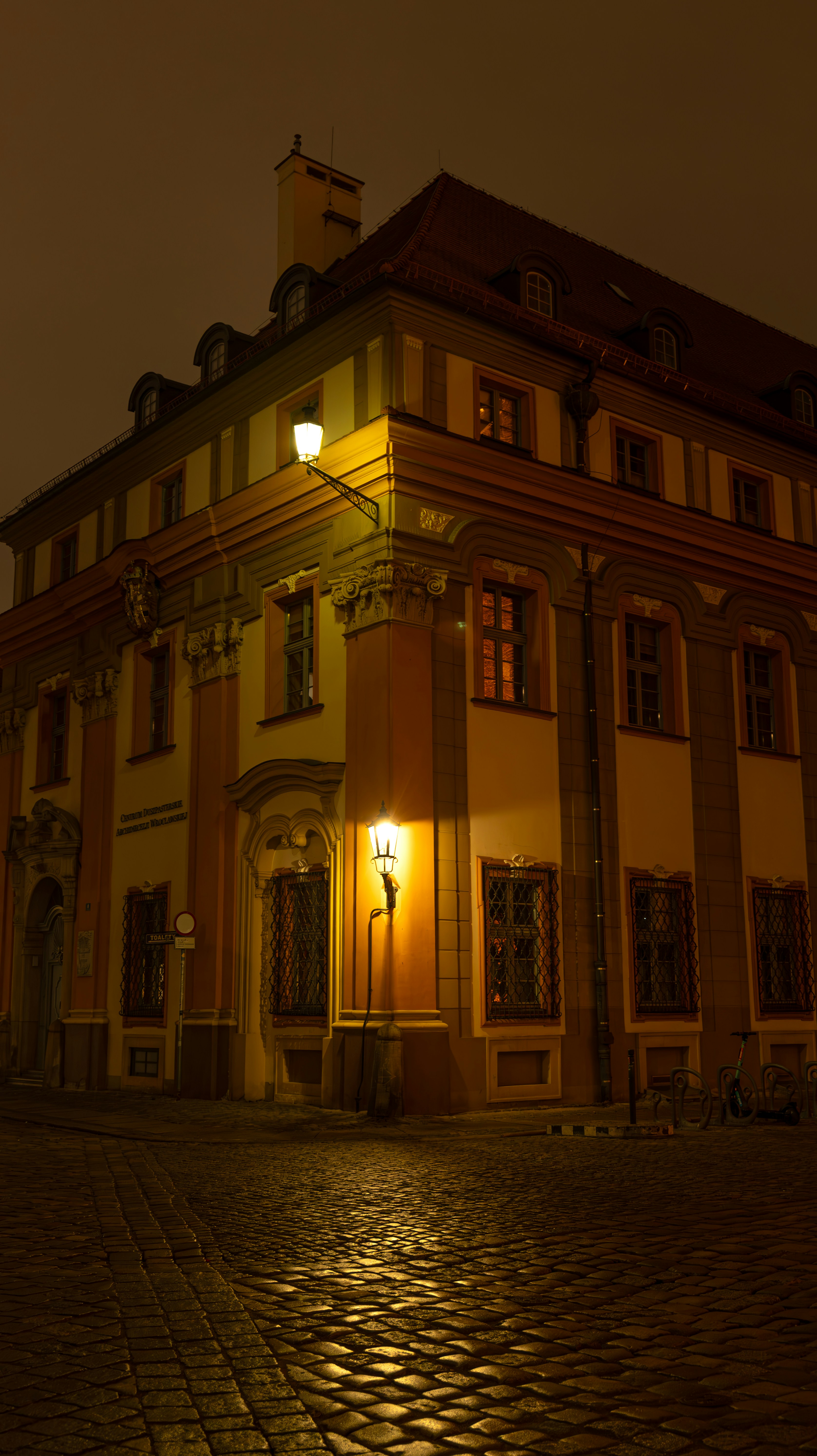 Old building illuminated by streetlights at night