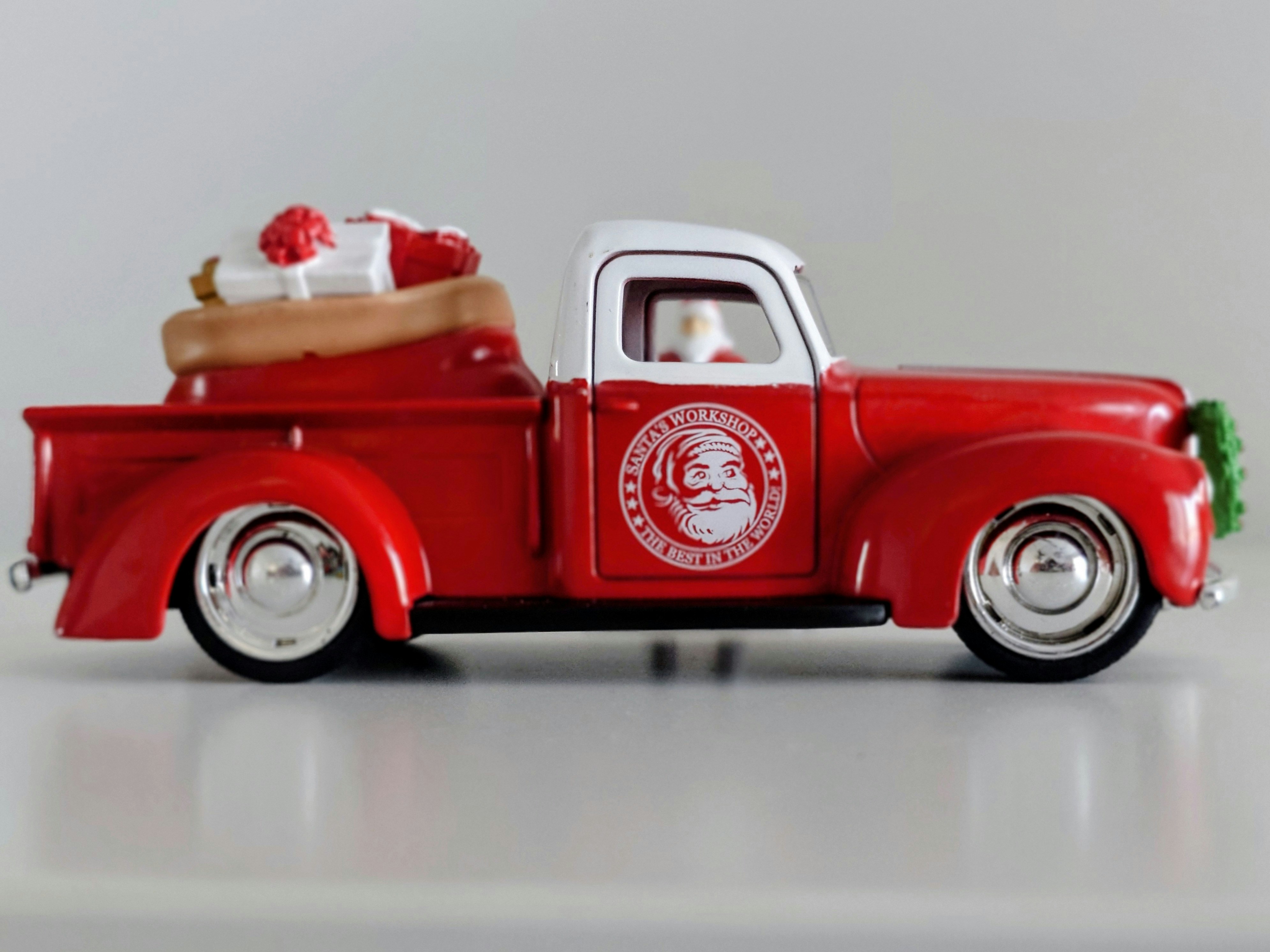 Red vintage toy truck with santa and gifts