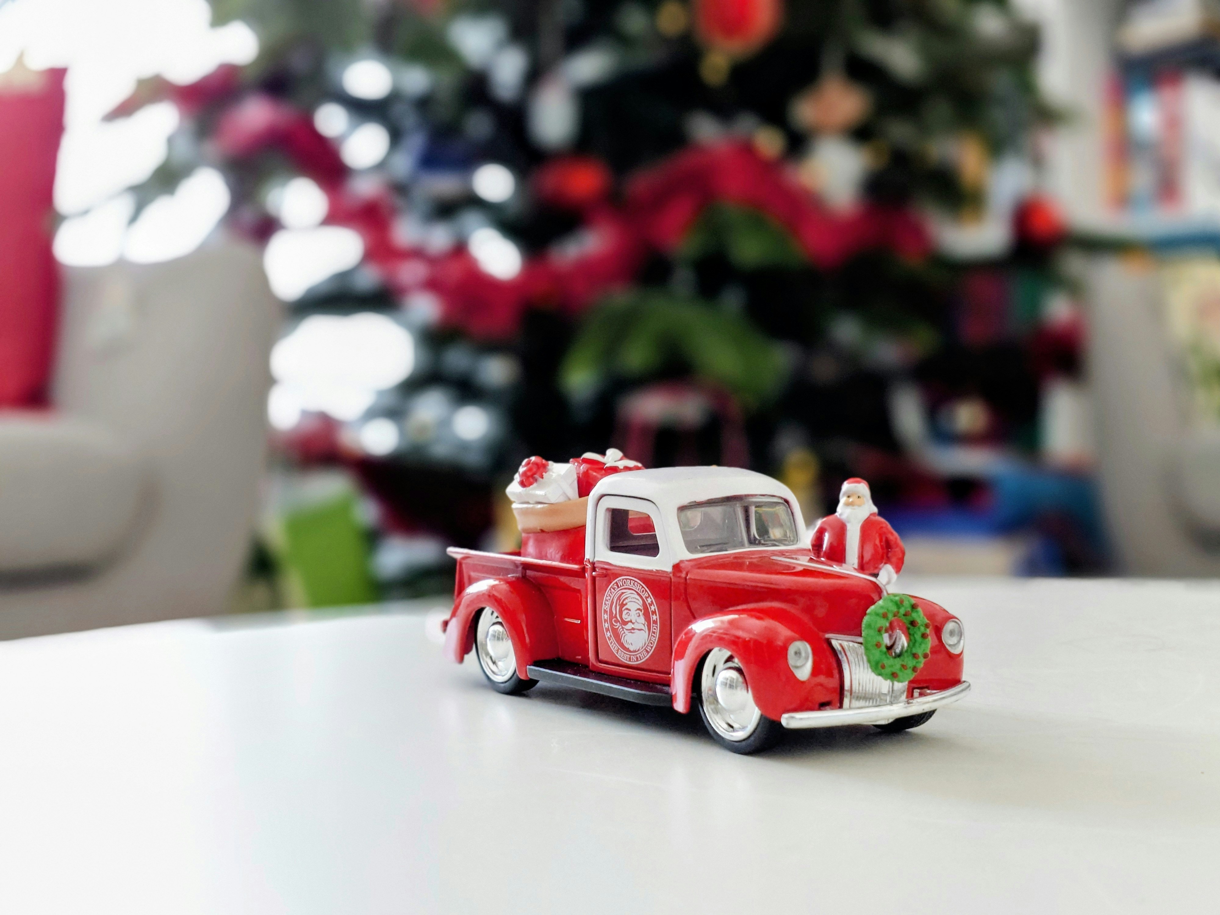 Red christmas truck with gifts and gifts on table