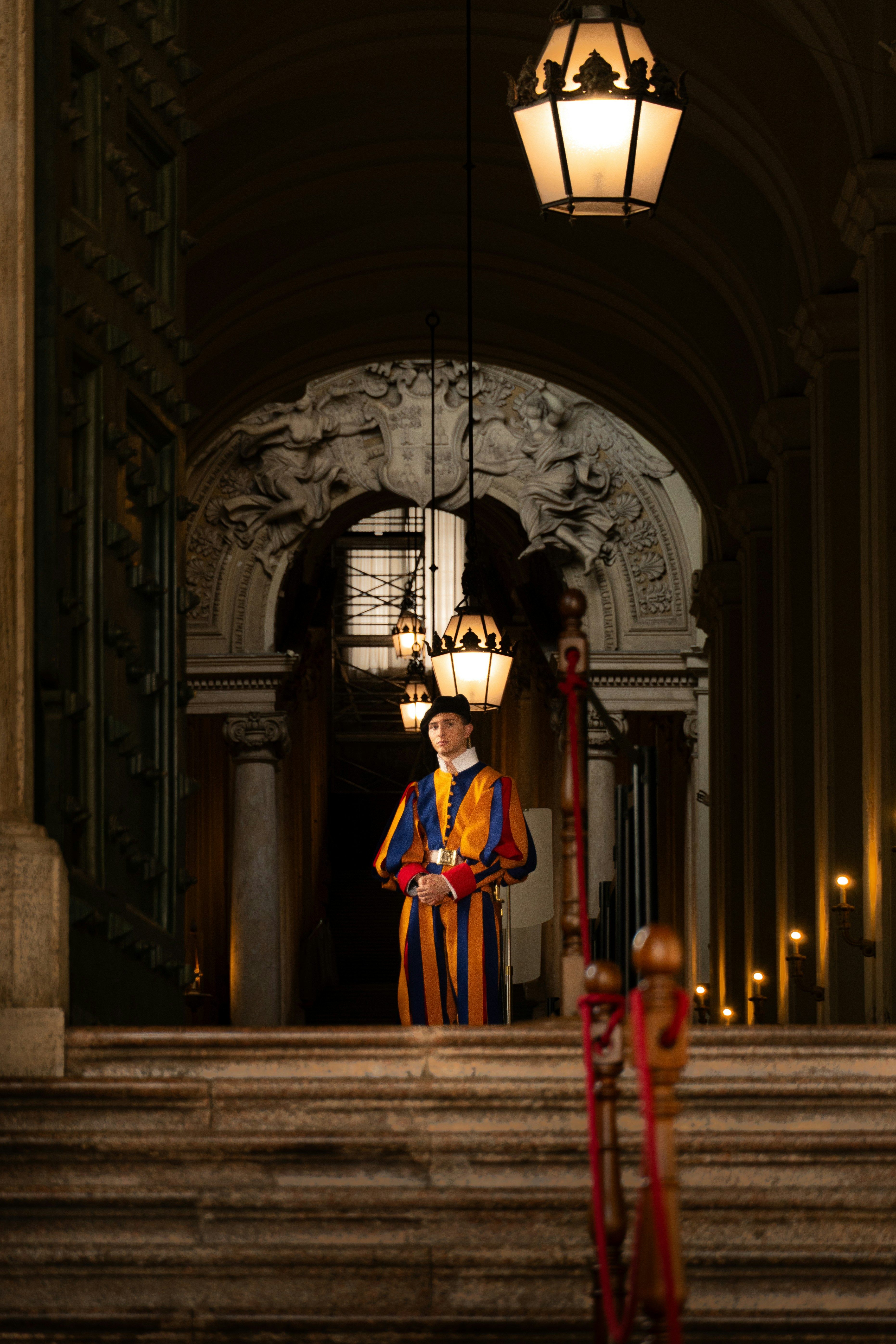 Uniformed Sentinel in a Dim Grand Hall