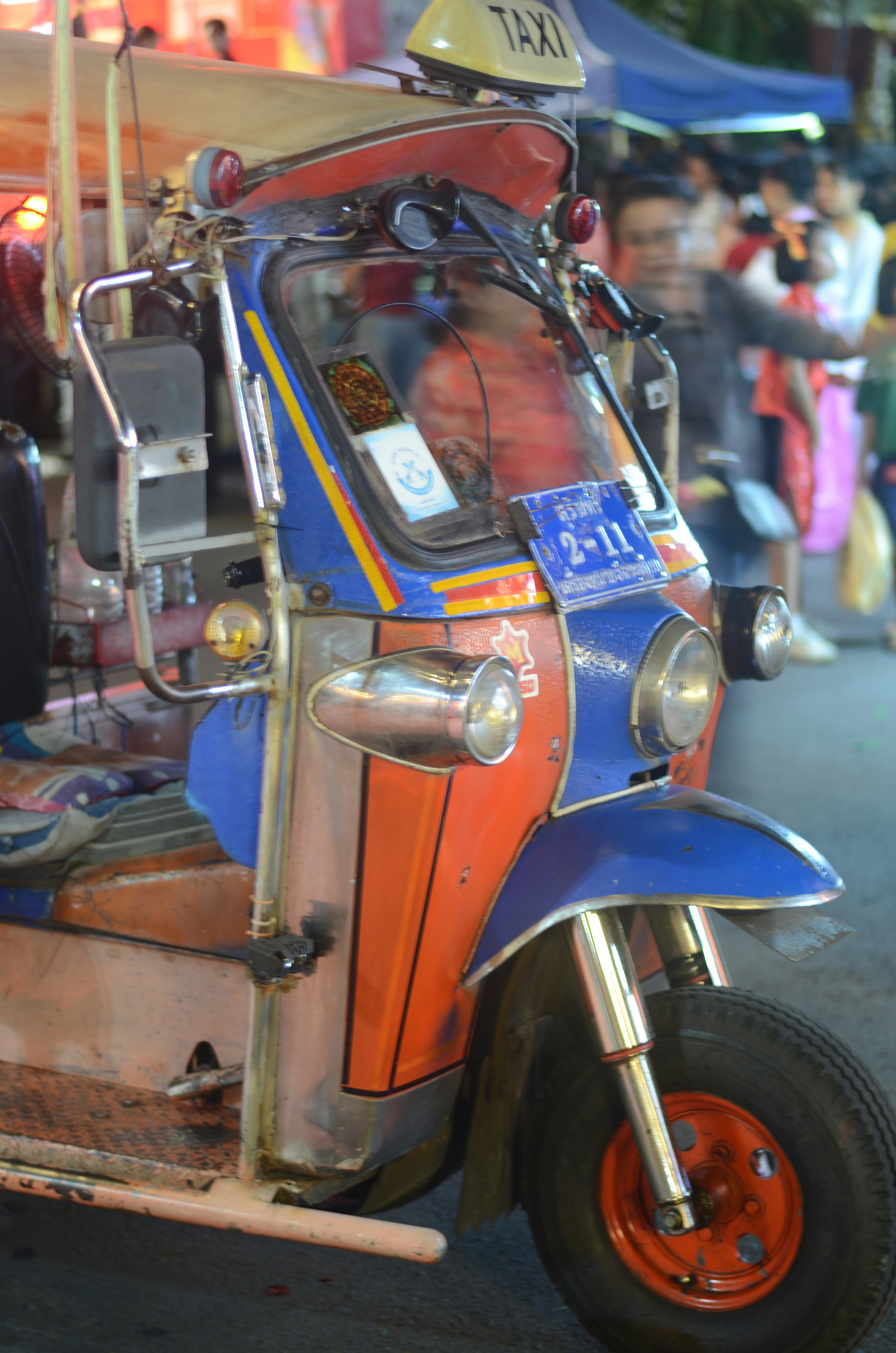 Colorful taxi-rickshaw close-up under festival lights