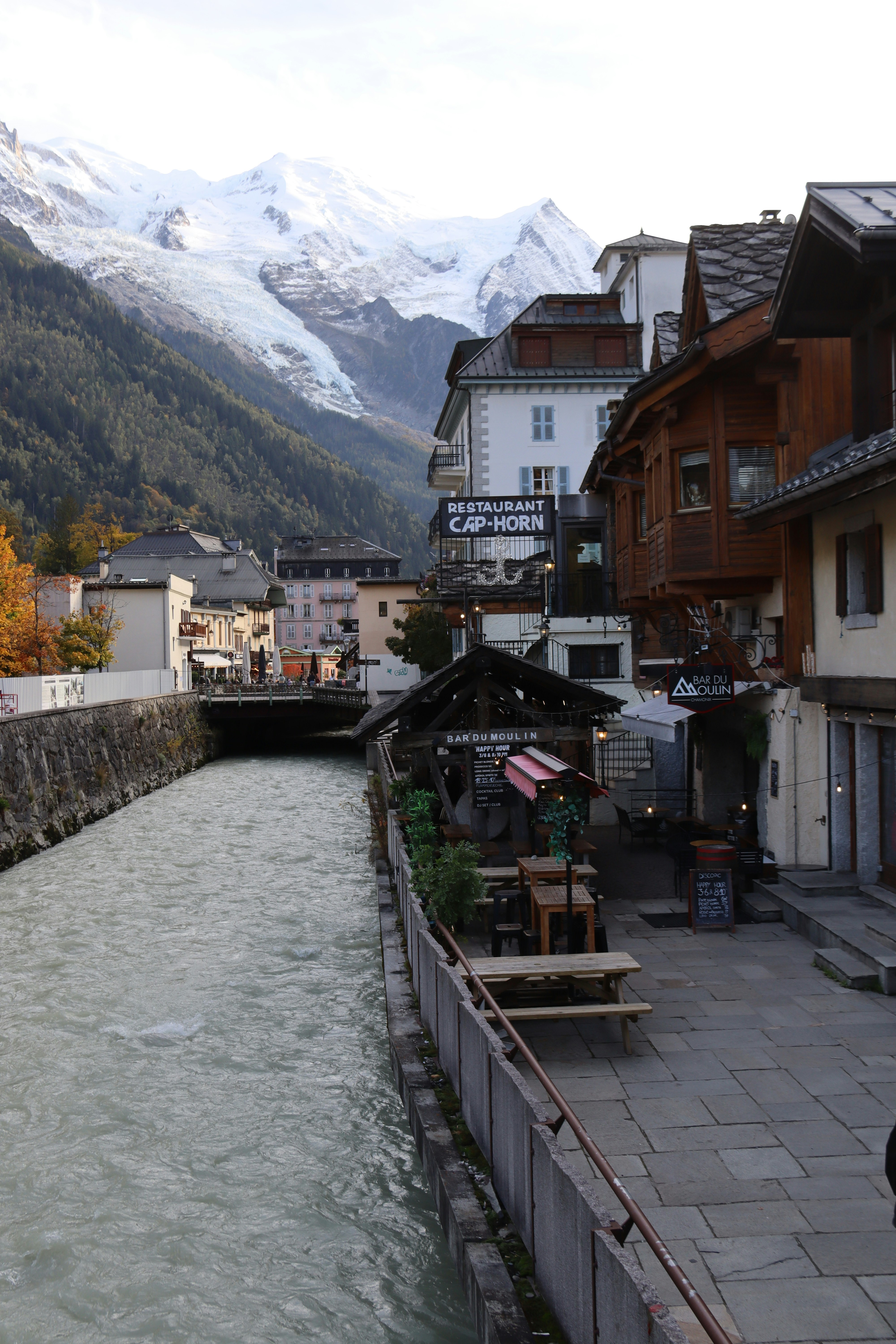 Riverside Alpine Village with Mountain Backdrop