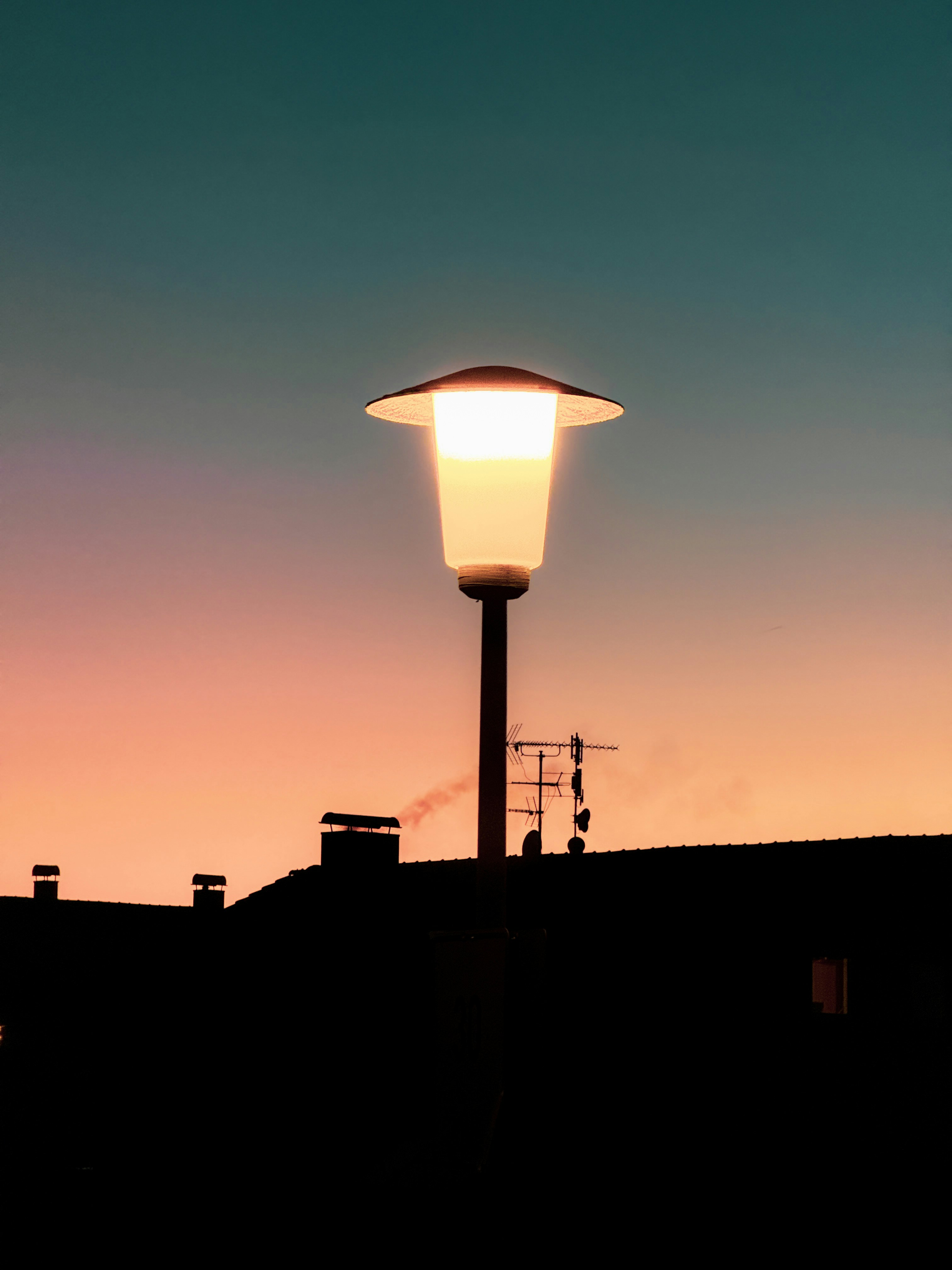 Lone Lantern at Dusk: A Sunset Silhouette