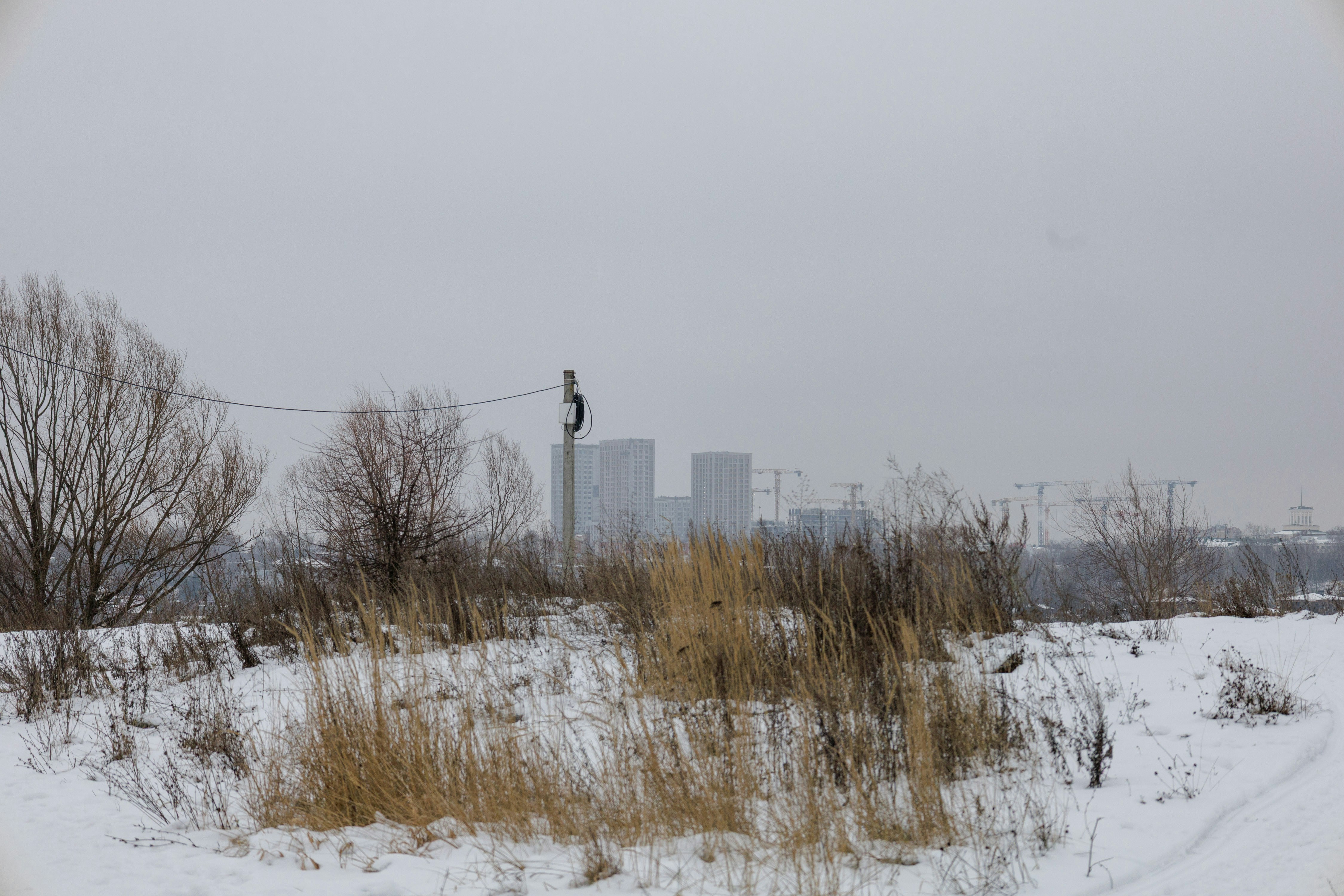 Industrial silhouettes over a snow-dusted field