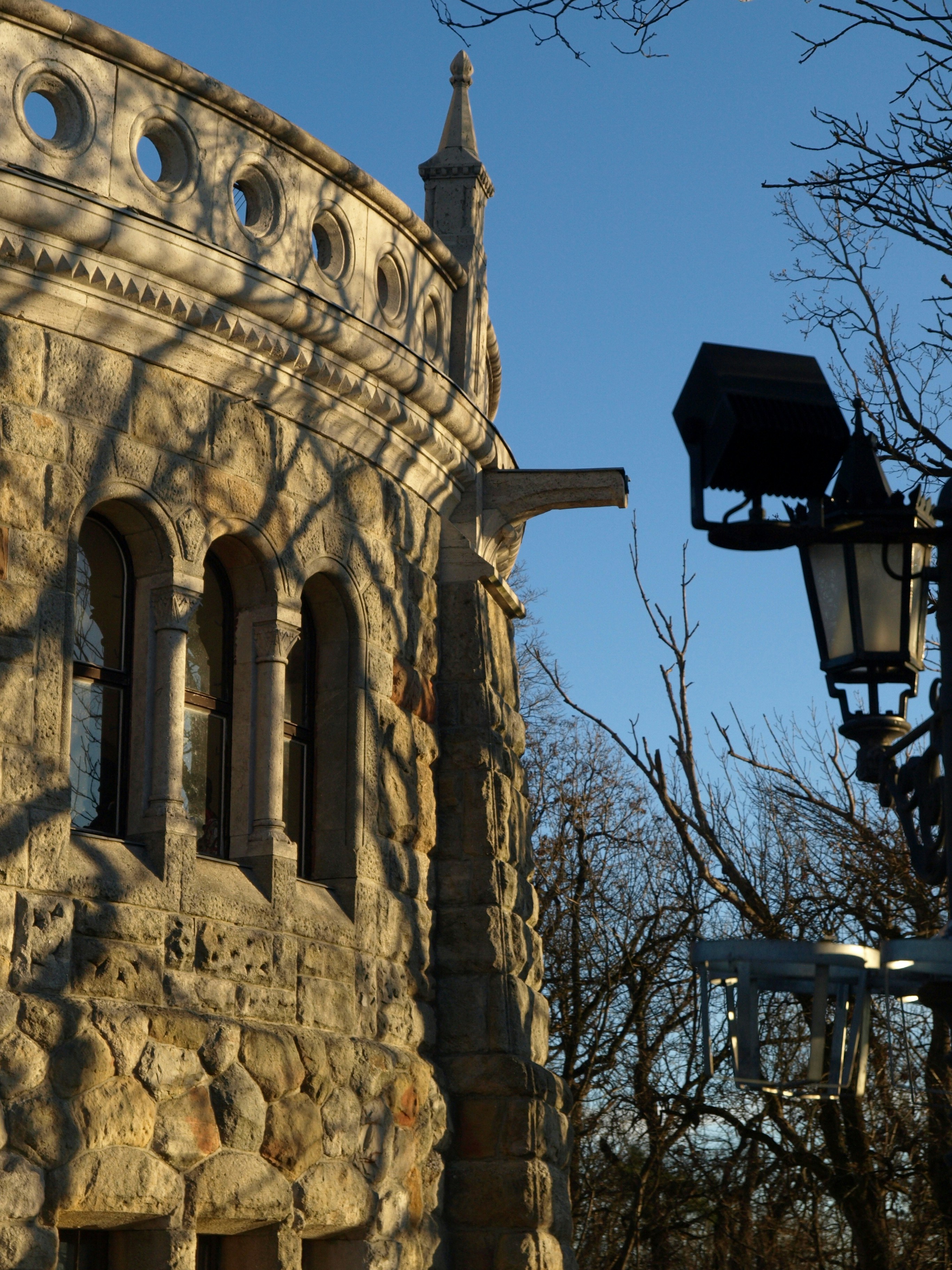 Stone building with arched windows and gargoyle