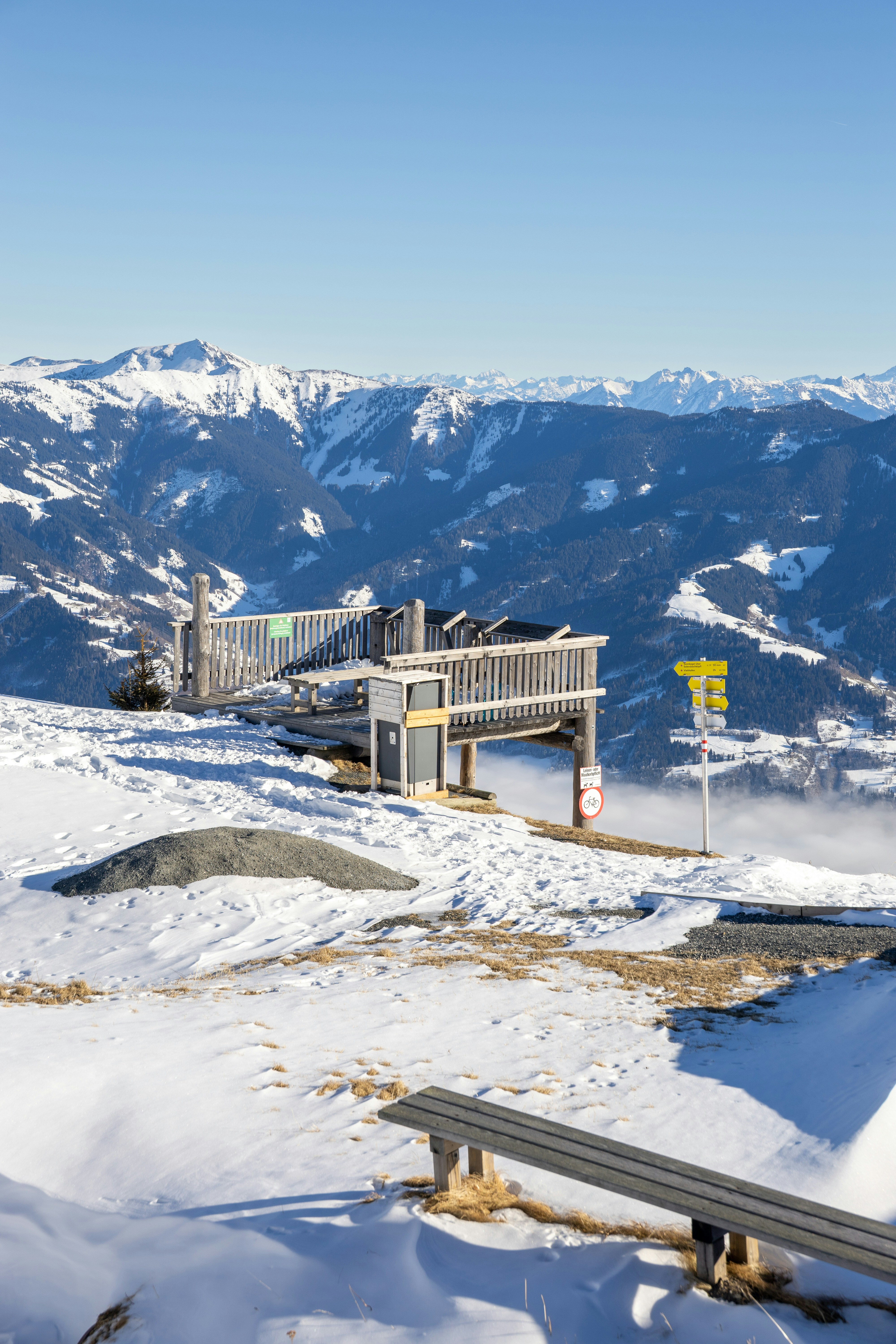 Mountain Overlook with Snowy Deck and Atmospheric Mist