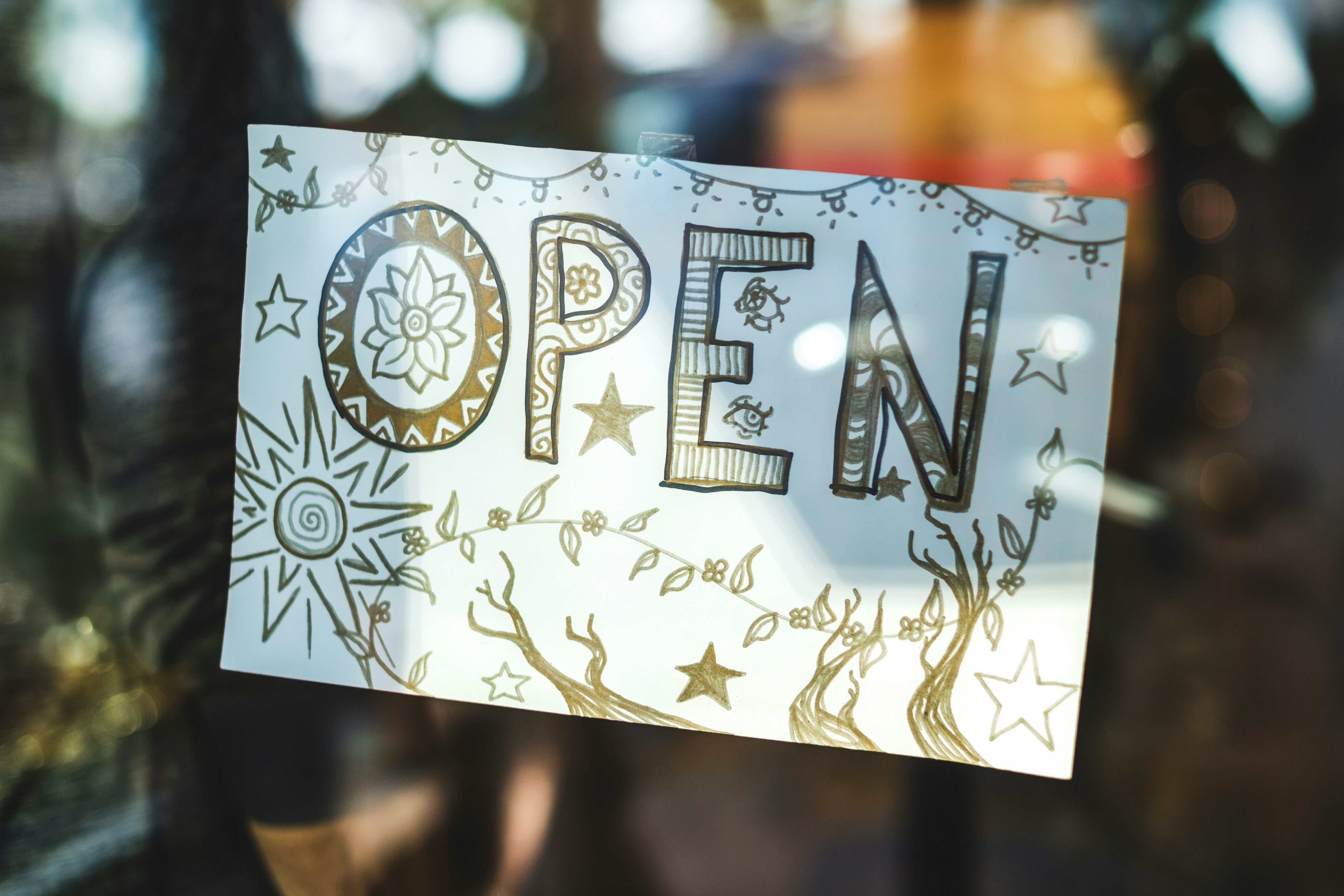 Open Sign in a Blurred Shop Window