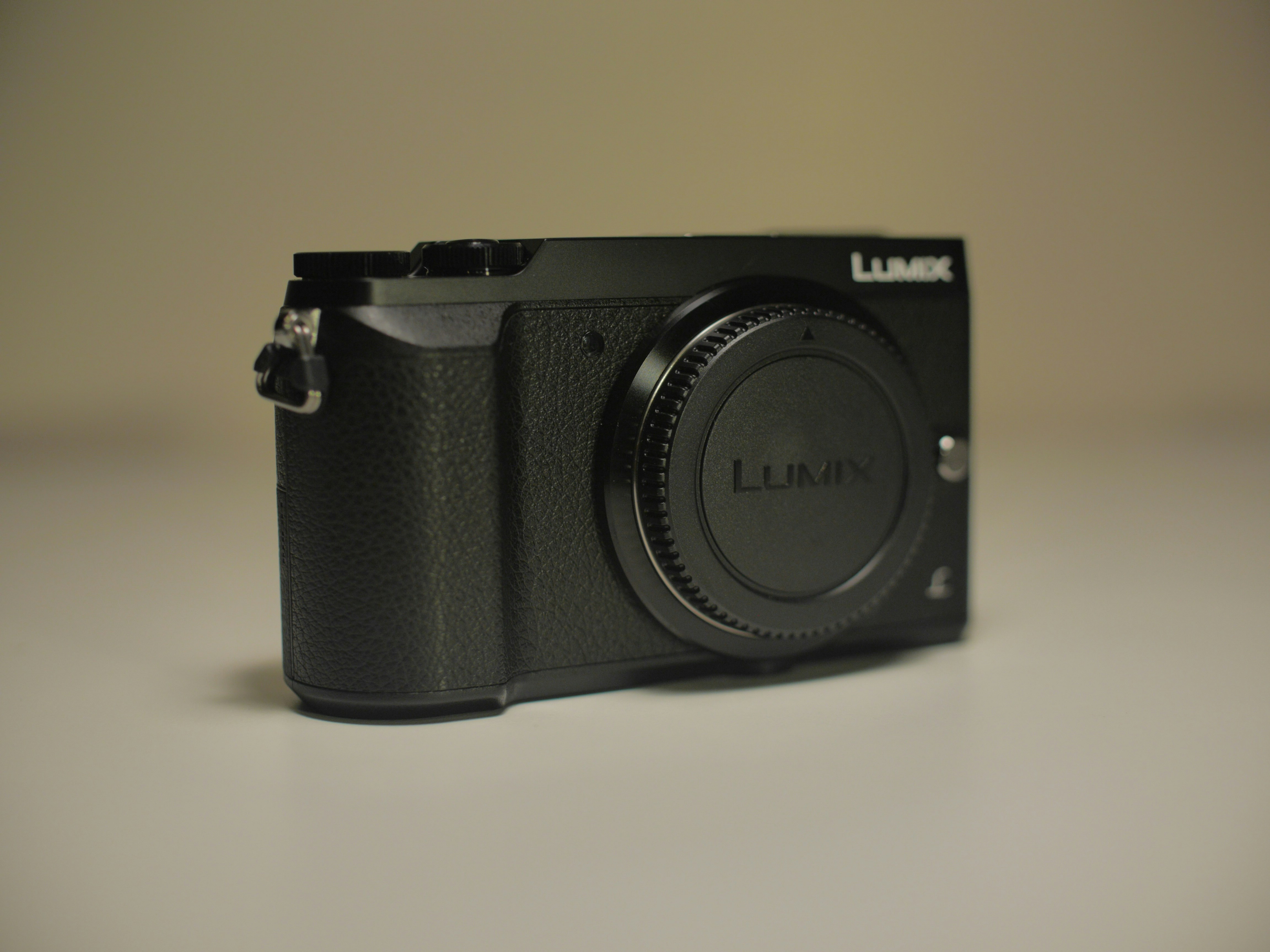Black lumix camera with lens cap on