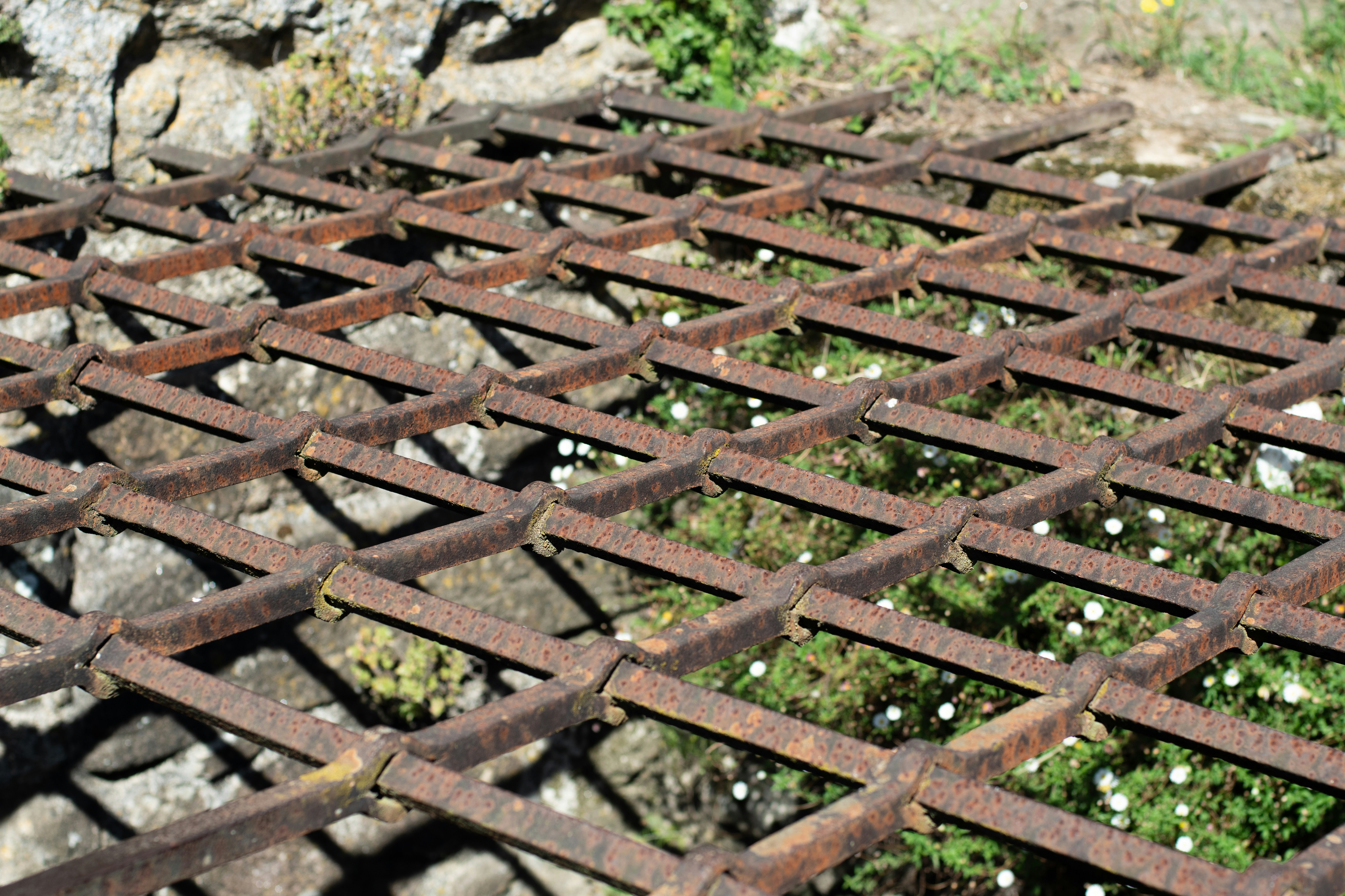 Rusted Grid Over Concrete Ruins