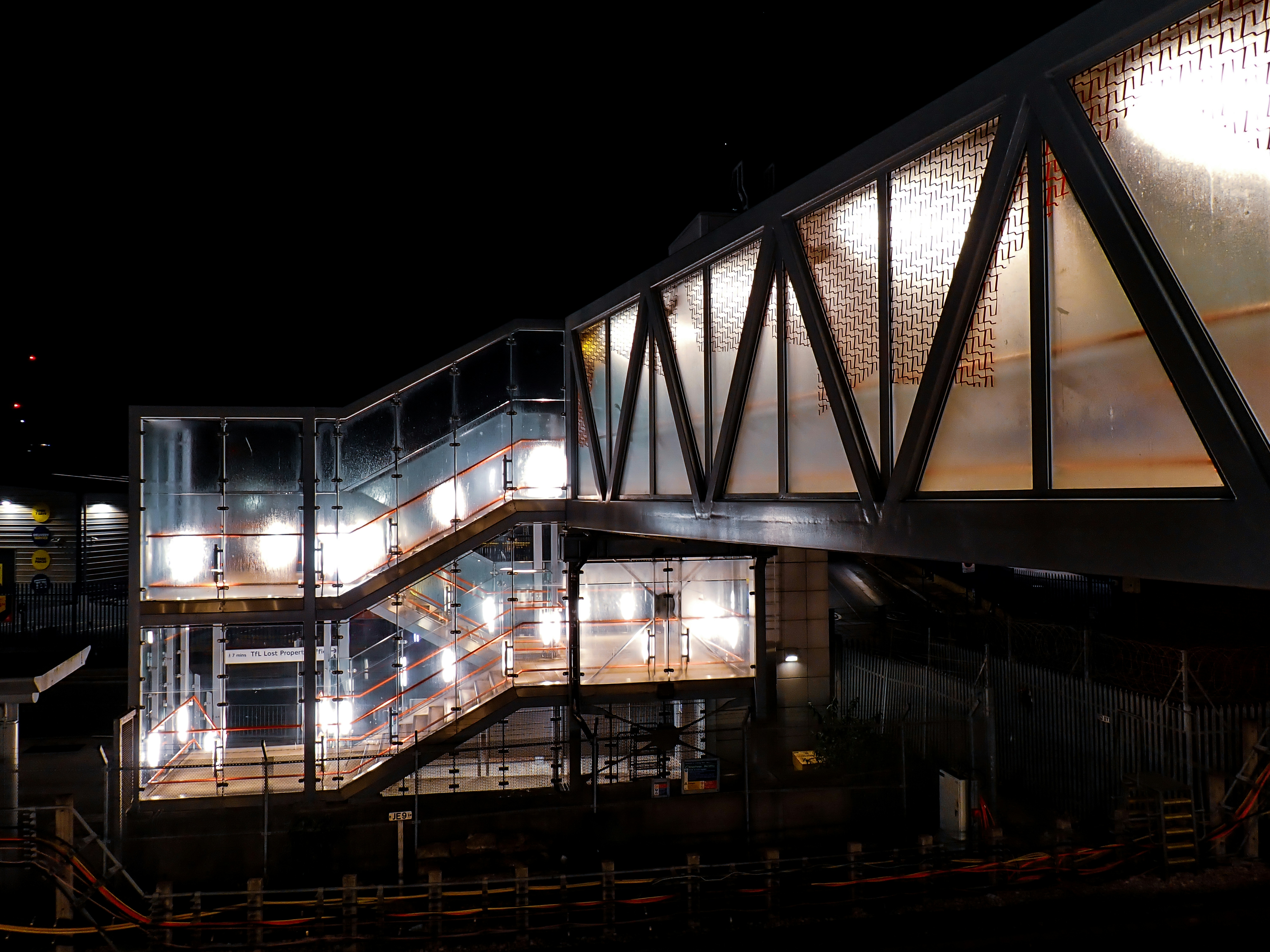 Modern illuminated pedestrian bridge at night