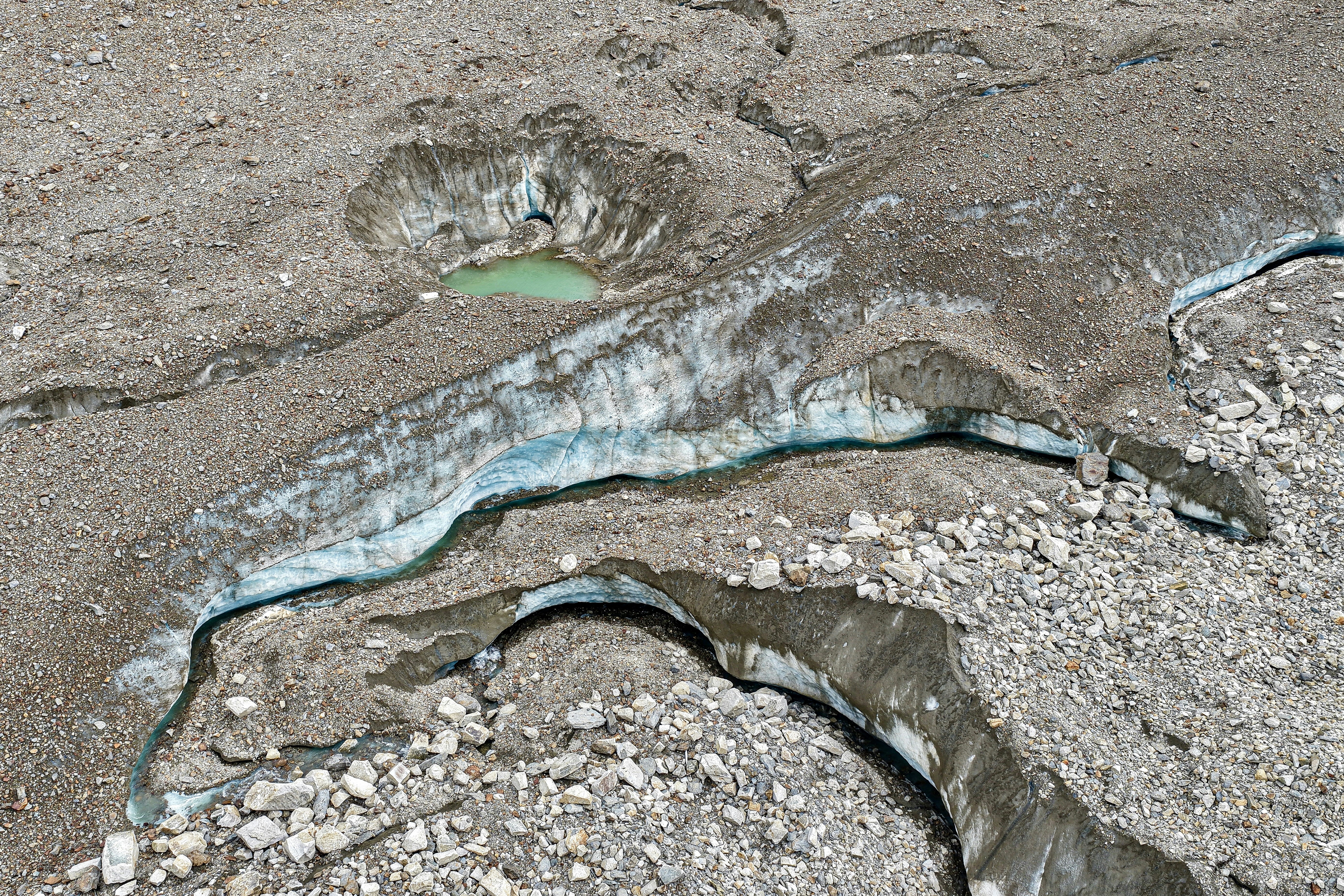 Glacier meltwater stream flowing through rocky terrain.