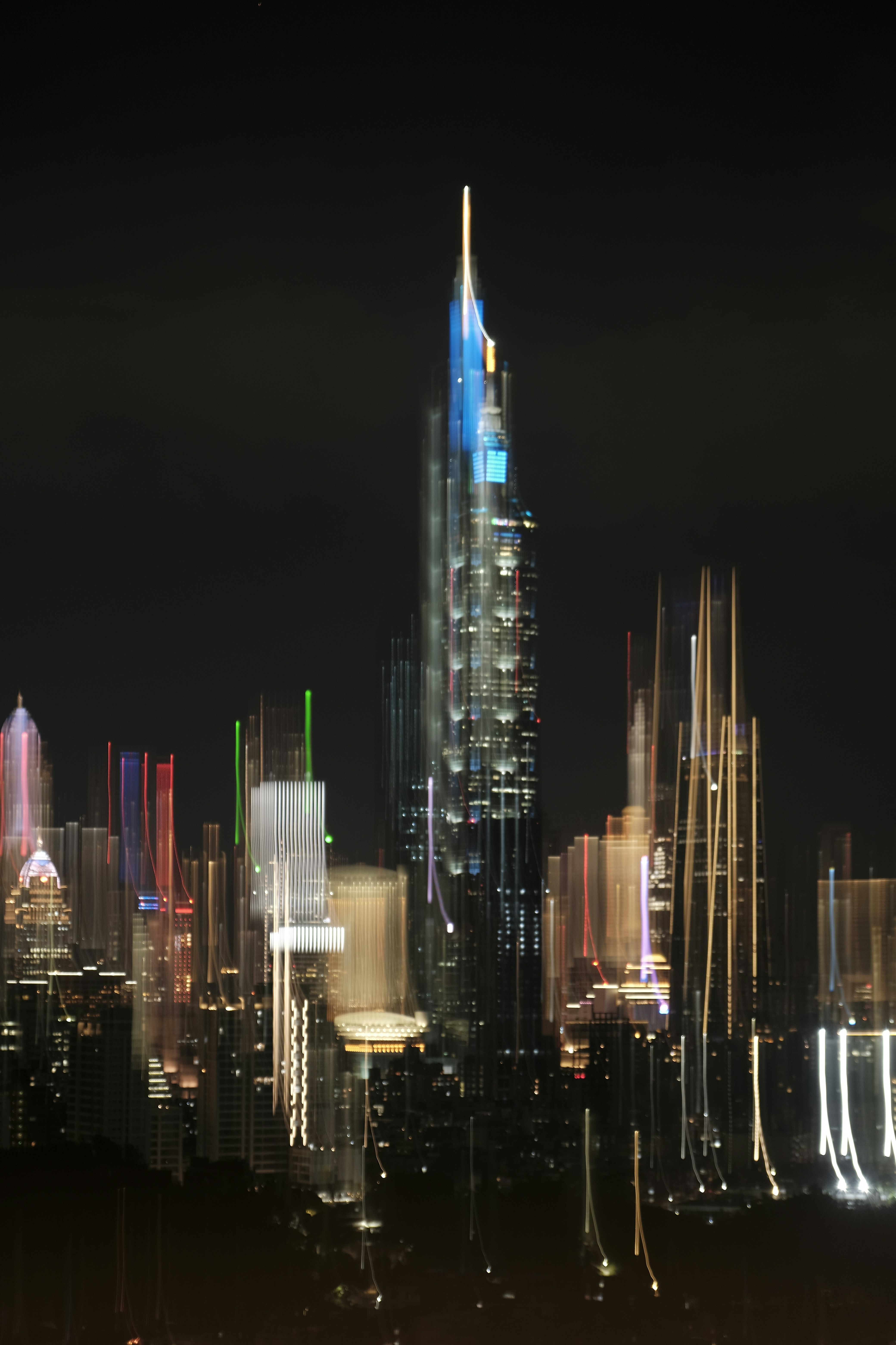 Blurry cityscape with tall buildings at night. photo – Free ...