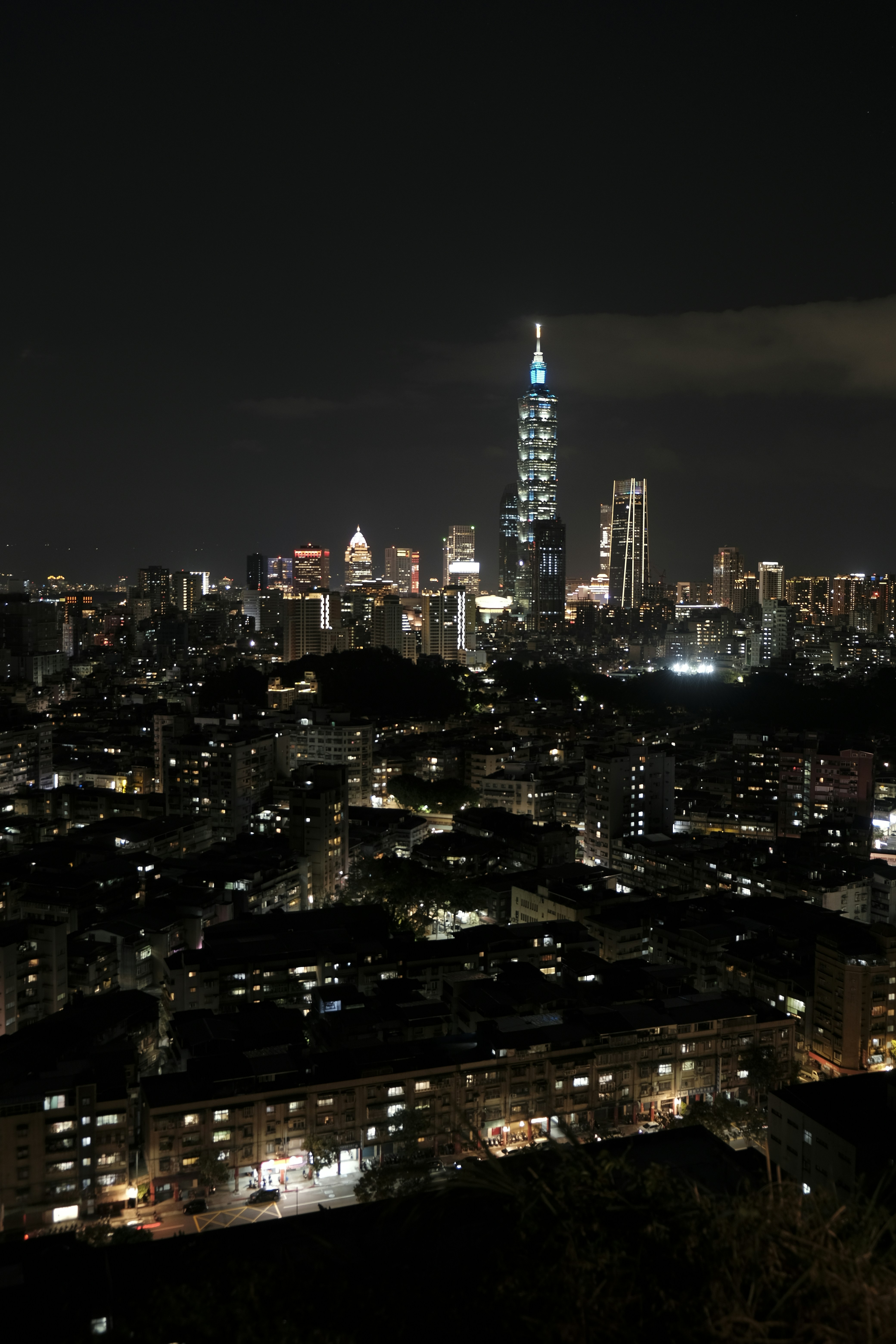 City Lights Crowned by a Silent Giant