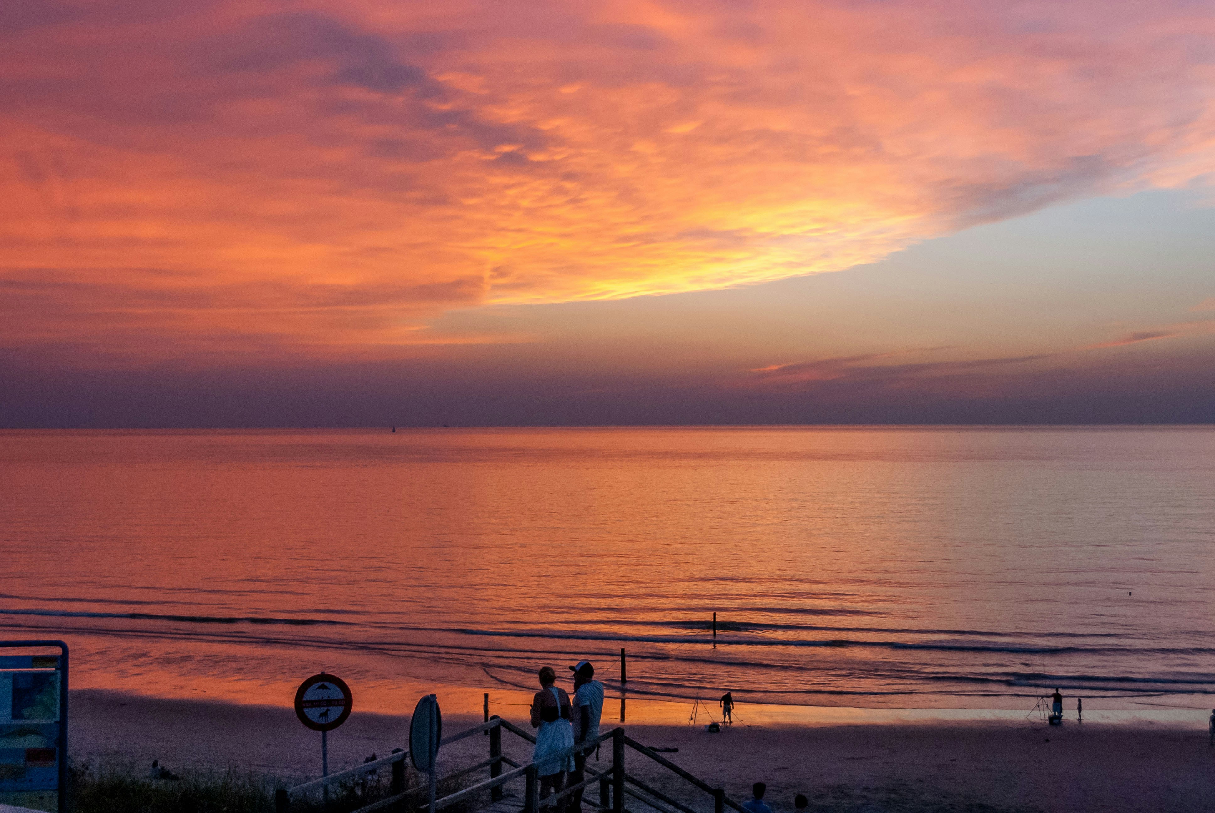  twilight by the shoreline: a warm glow over a quiet beach