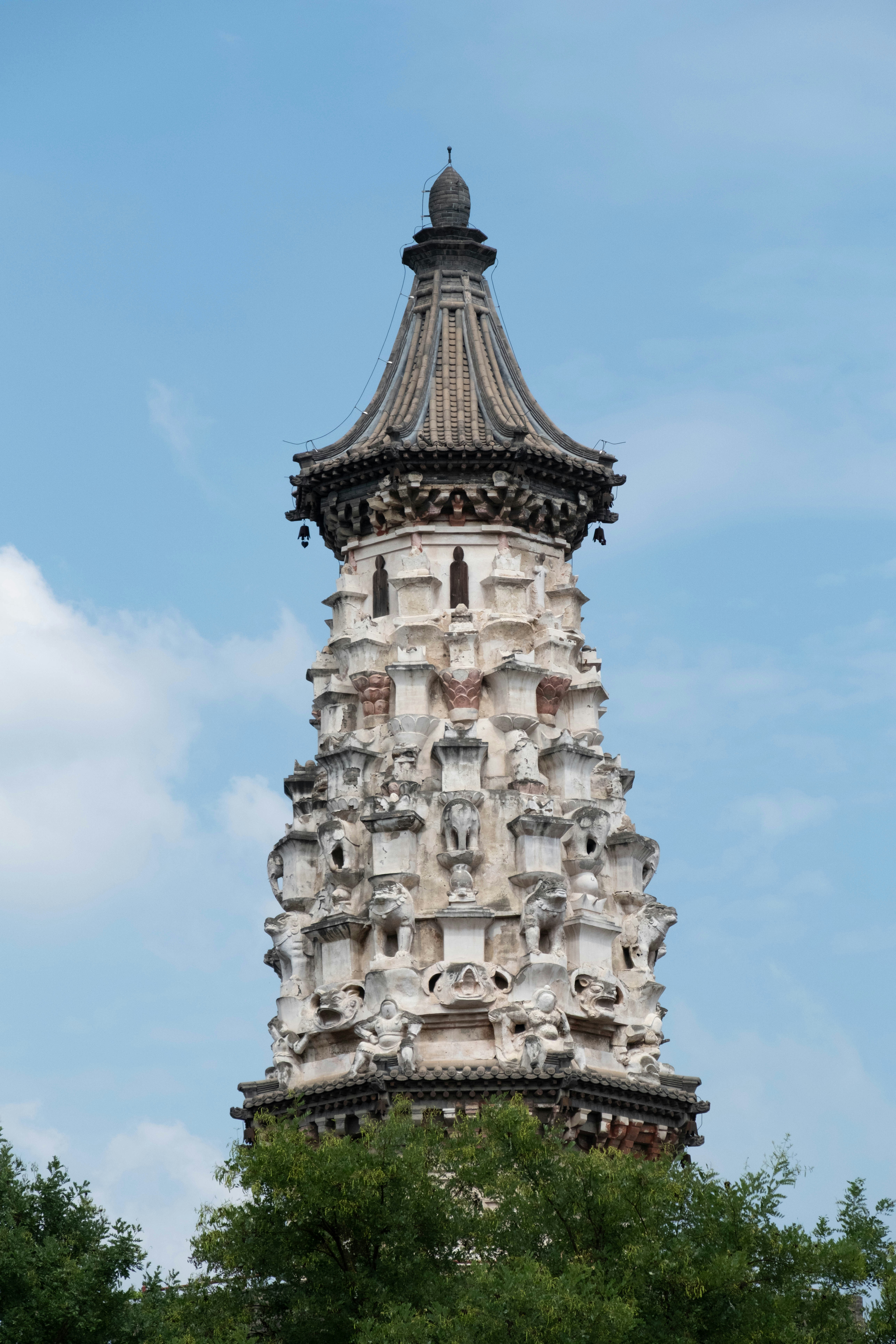 Stone Pagoda Crowned by a Carved Tapered Roof Against a Blue Sky