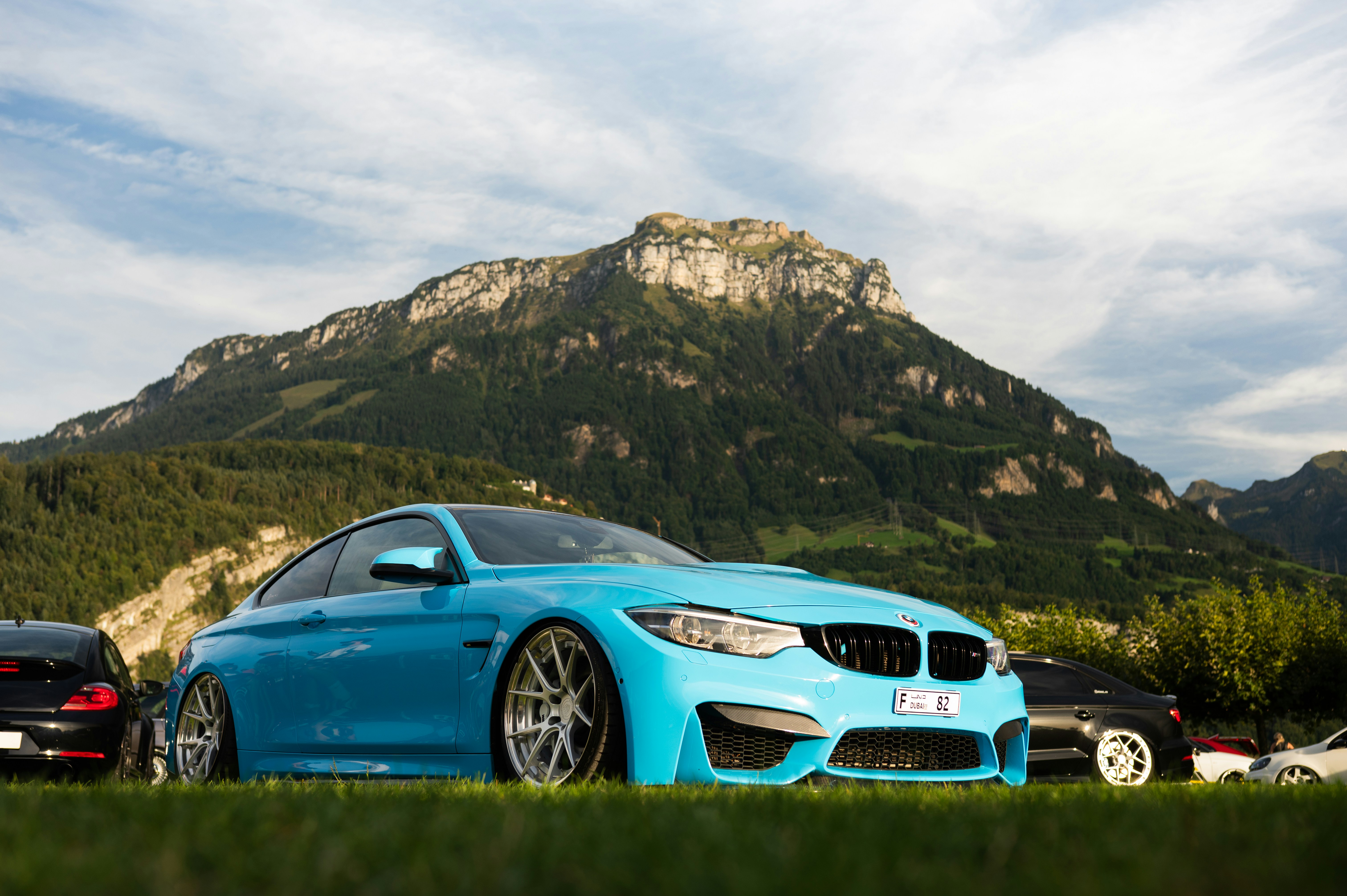 Blue sports car parked on grass with mountain background photo – Free ...