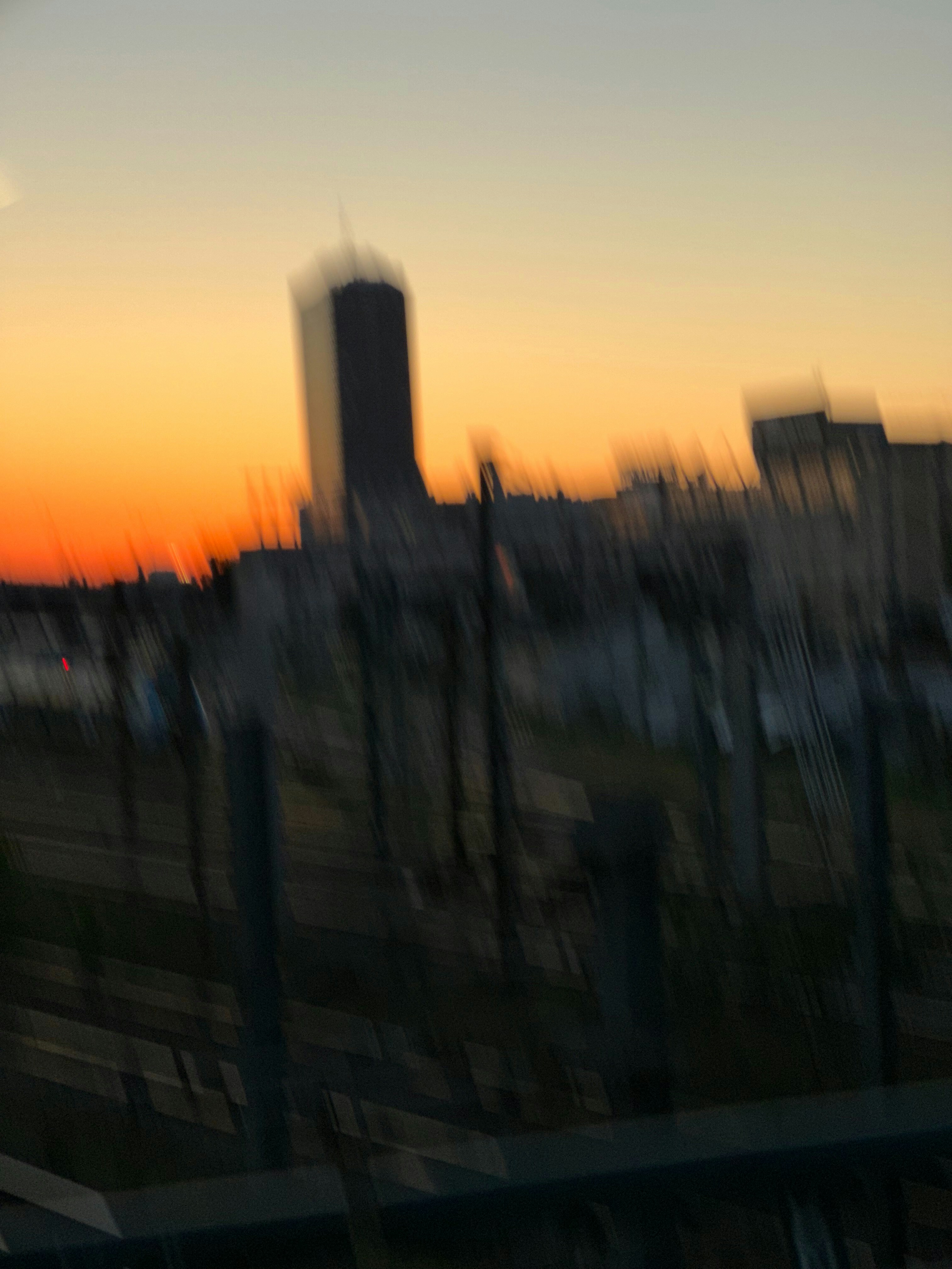Blurry Sunset Cityscape: Vertical Silence Over the Vineyards