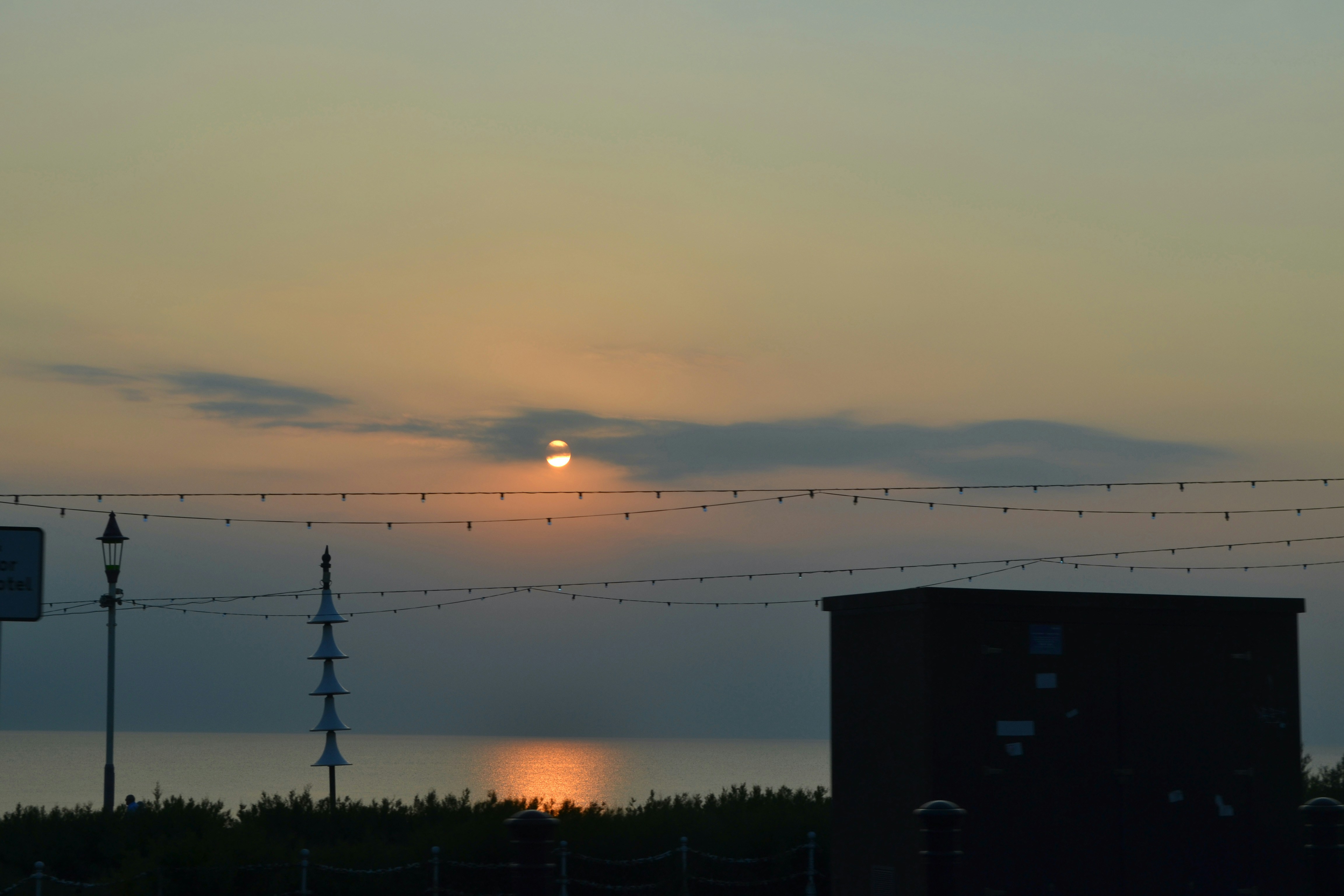 Sunlit Seascape at Dusk with Horizon Silhouette