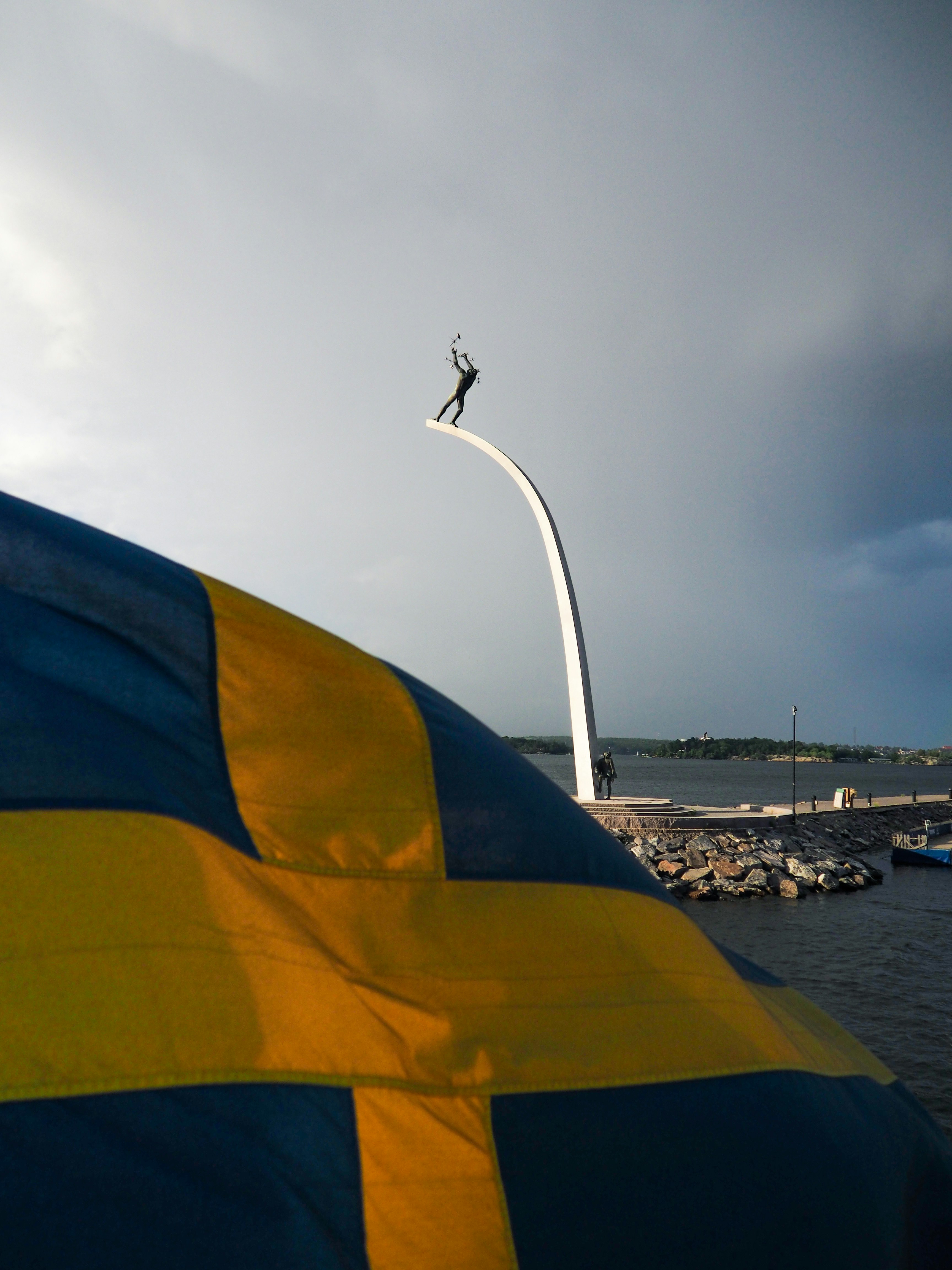 Arc of a Skypoint: A Figure Silhouetted on a Curved Monument