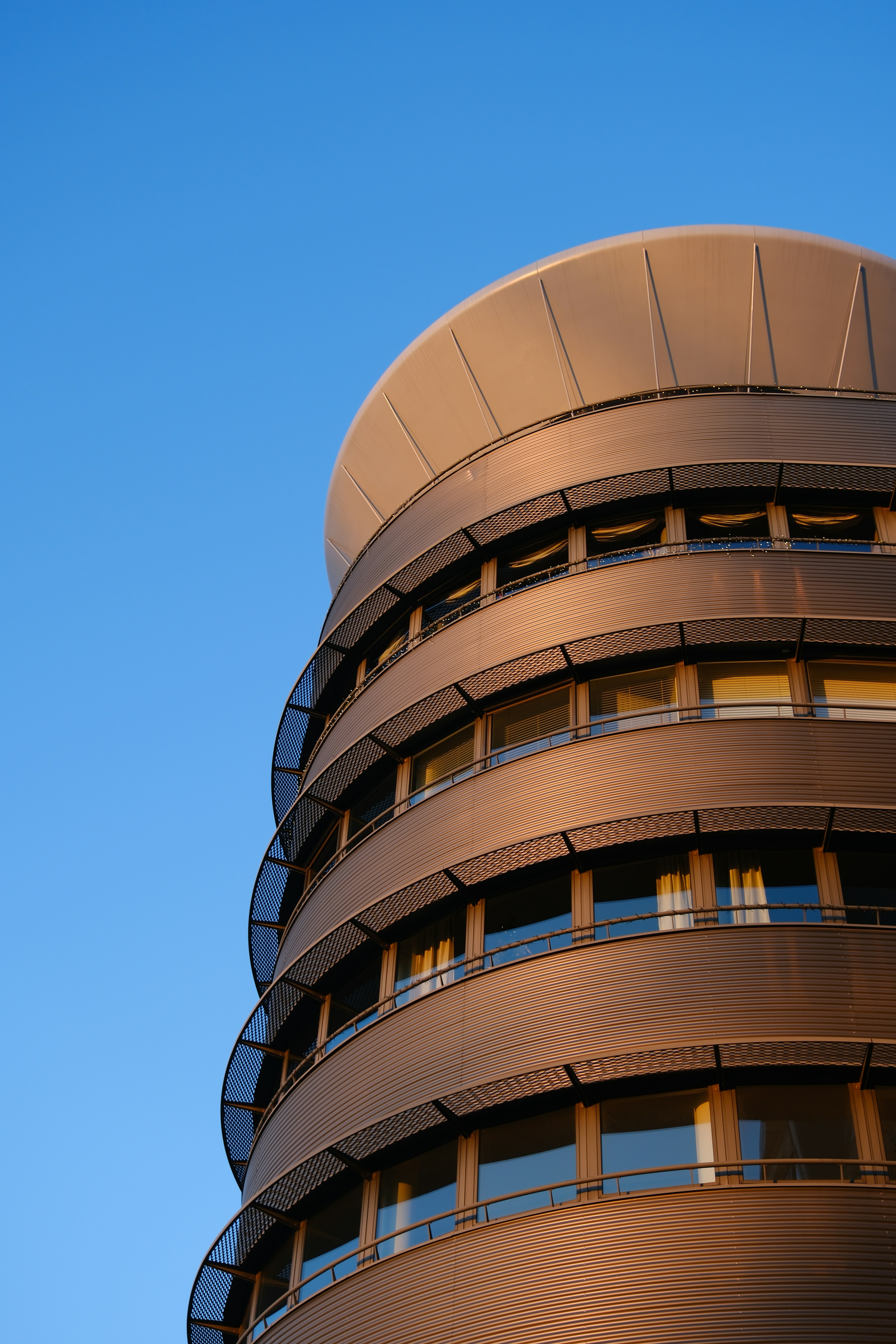 Rings of Steel: A Tower’s Circular Silence in Evening Light