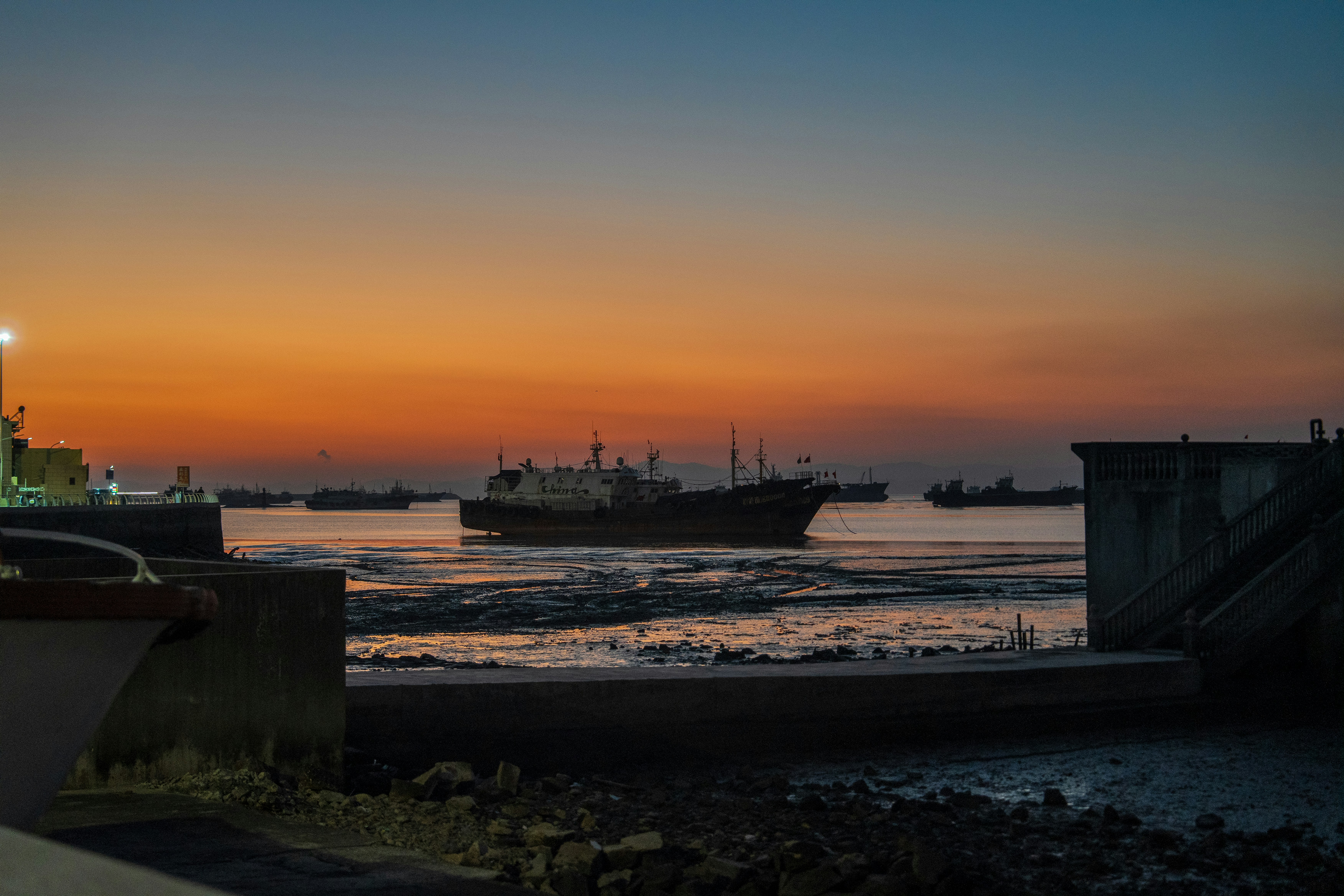  twilight harbor: ships slipping into dusk along a quiet pier