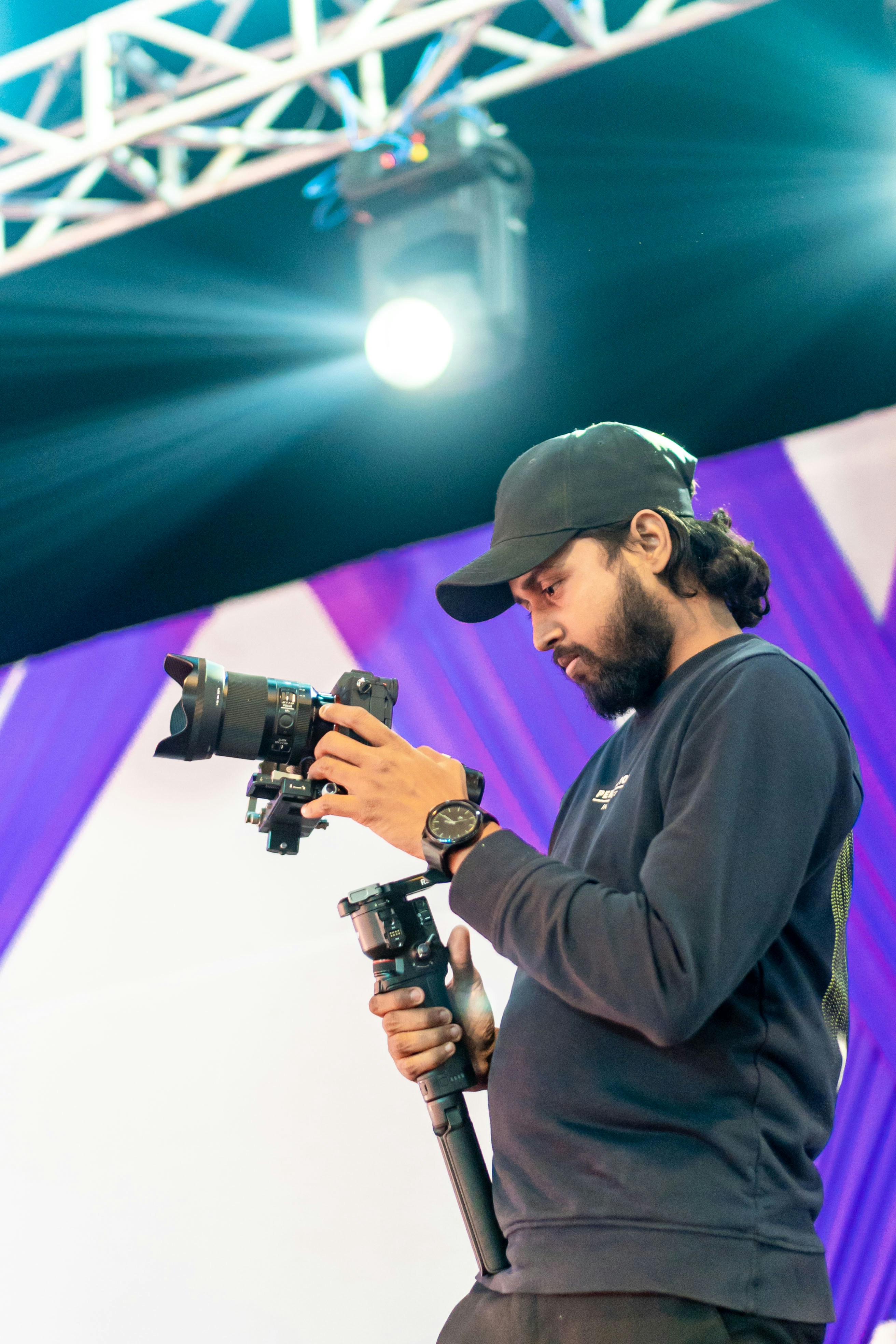 Portrait of Focus: A videographer in profile under stage lights