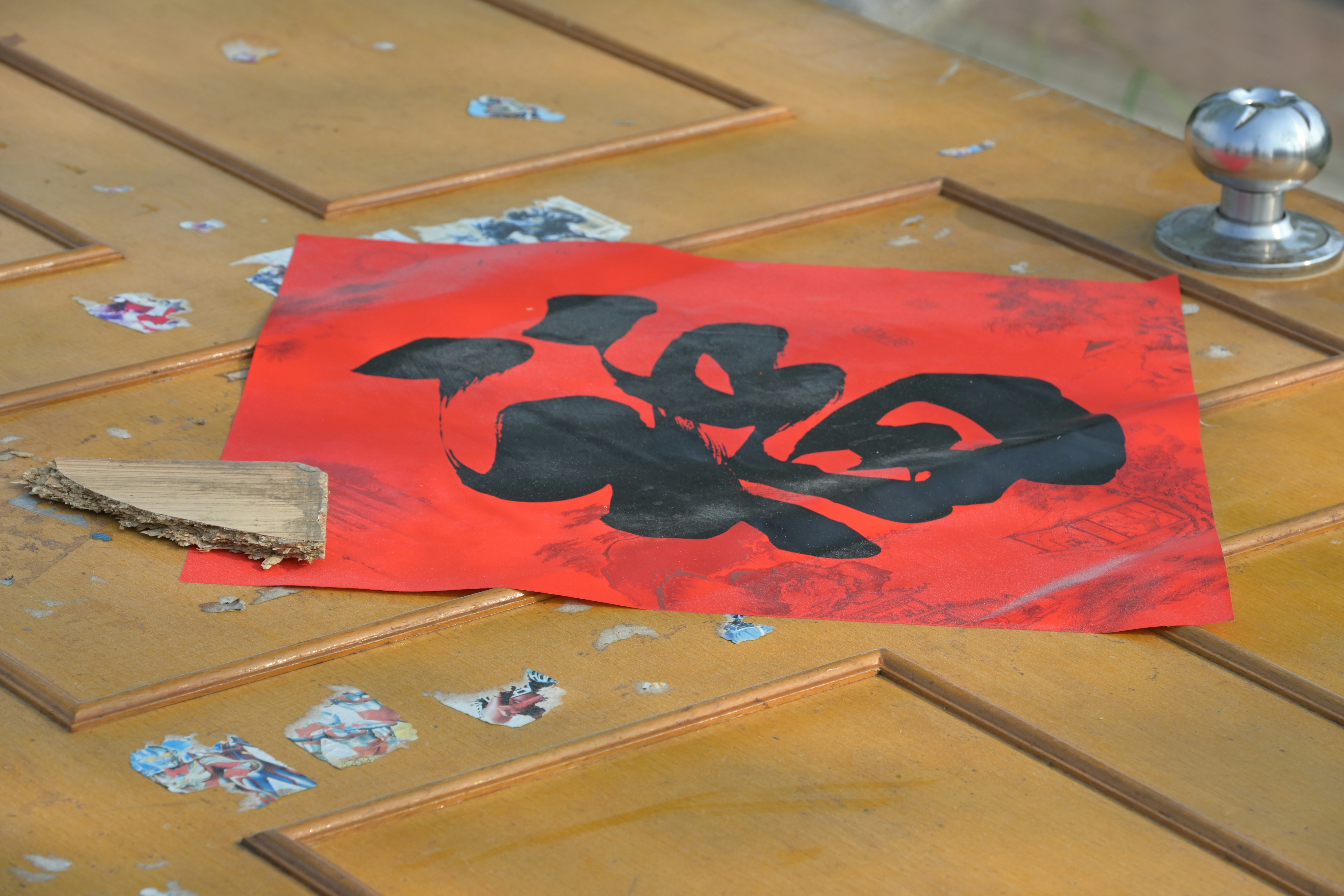 Red Chinese Calligraphy on Weathered Wooden Deck