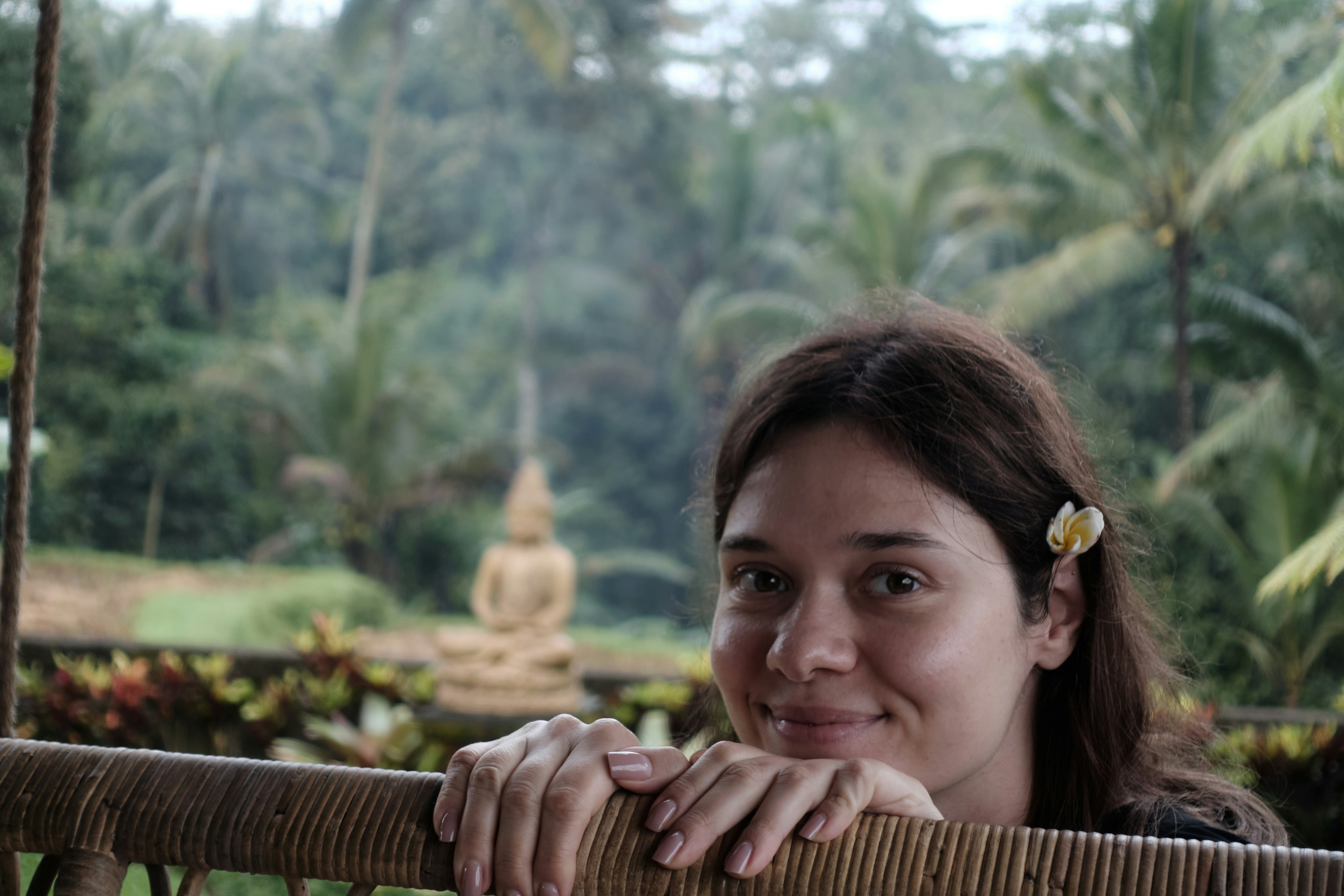 Gentle Smile Behind a Bamboo Railing