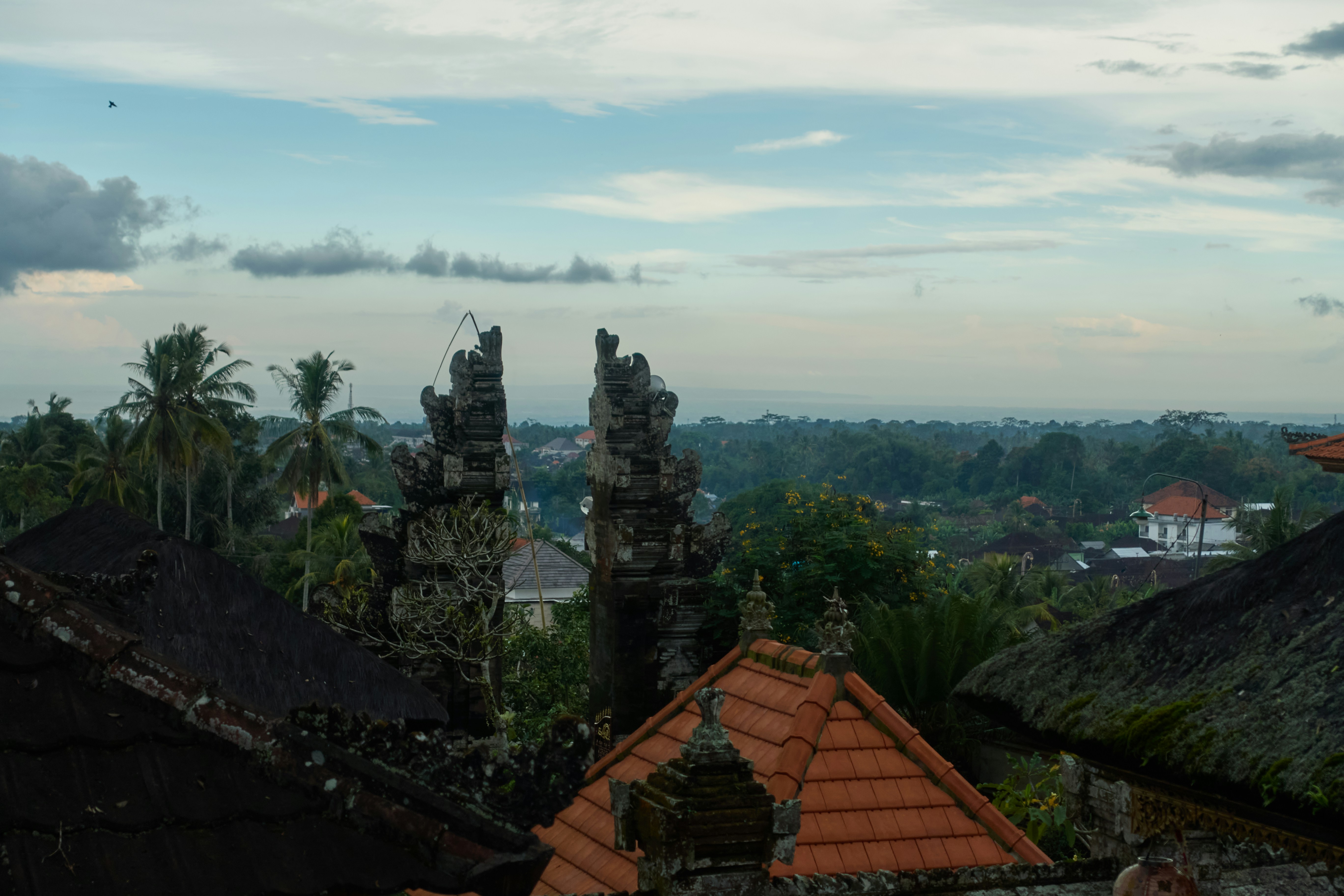 Temple Towers Framing a Balinese Sunset Over Rooftops