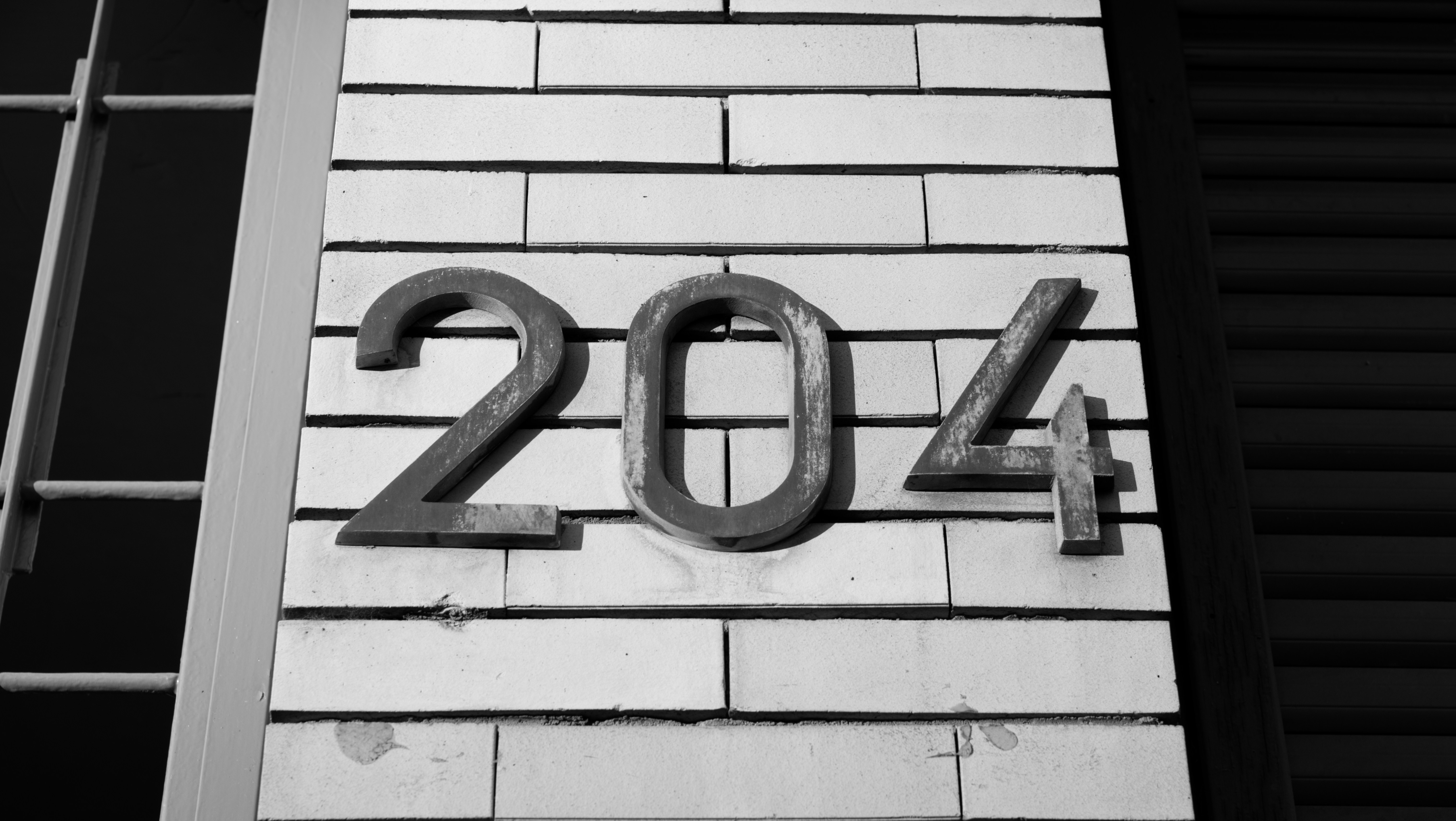 Brick Facade with Metallic 204 Plaque