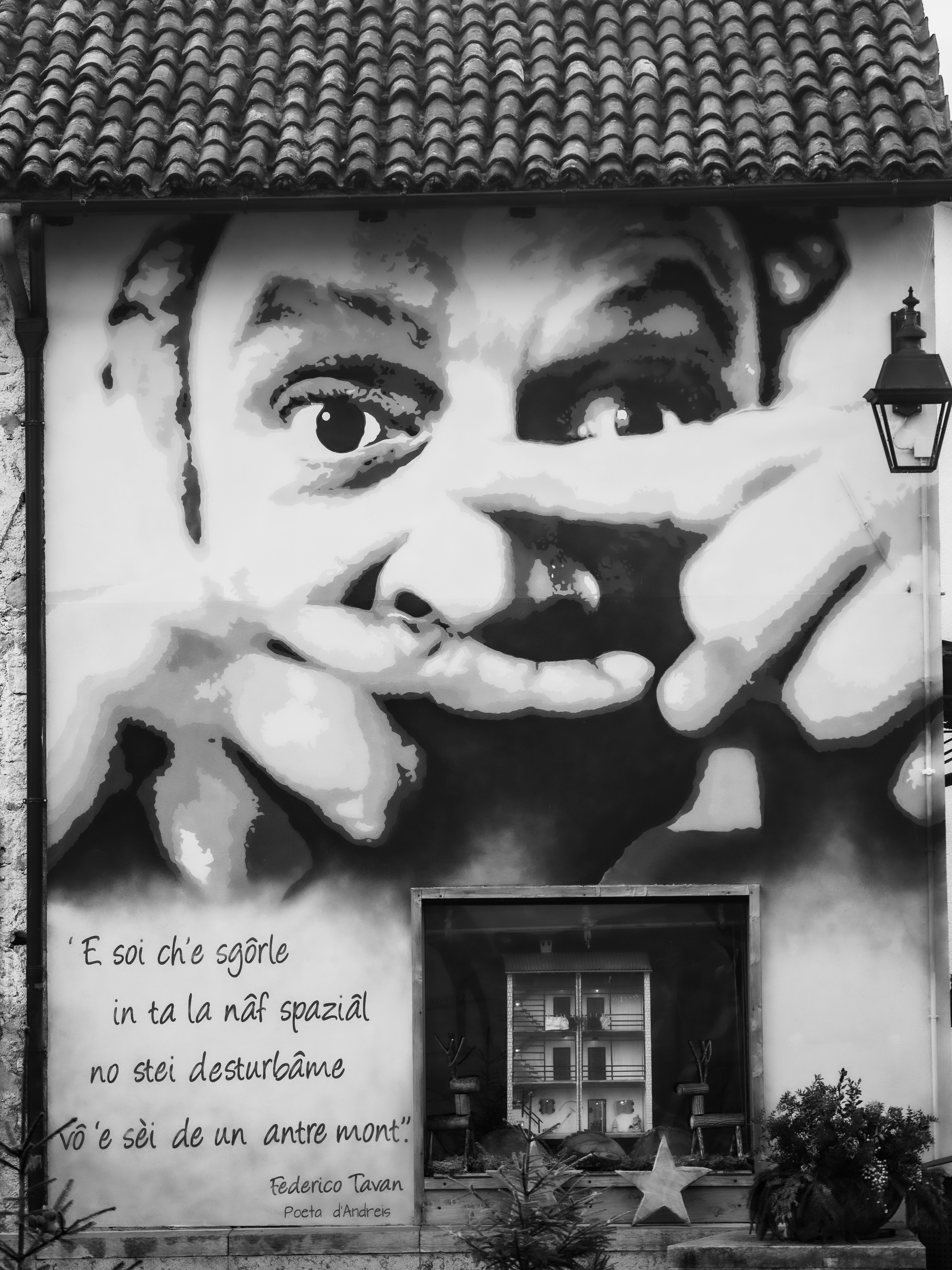 Giant mural gaze: a monochrome dialogue with a doorway beneath a painted eye