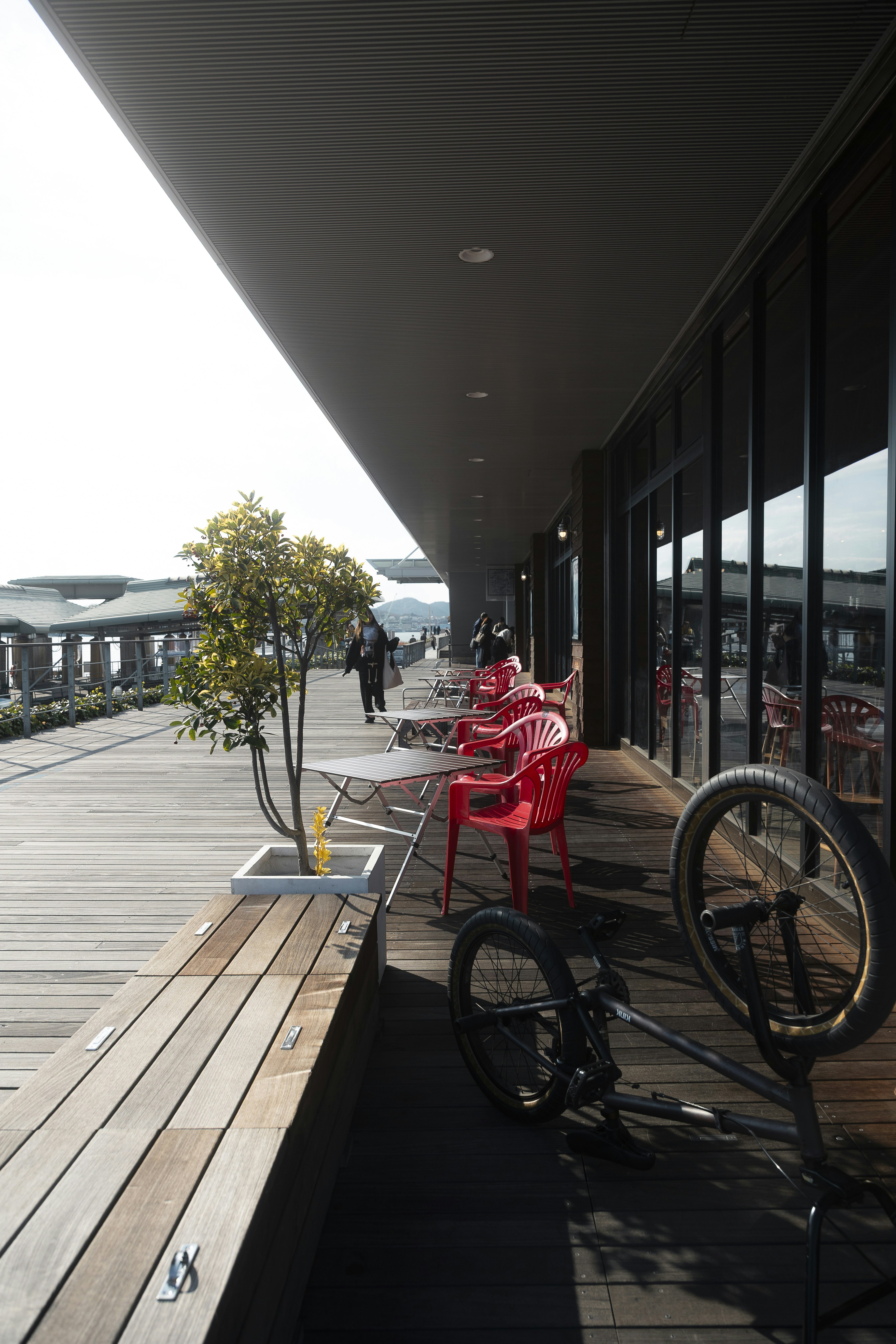 Cafe Terrace on the Boardwalk with a Straddling Bicycle