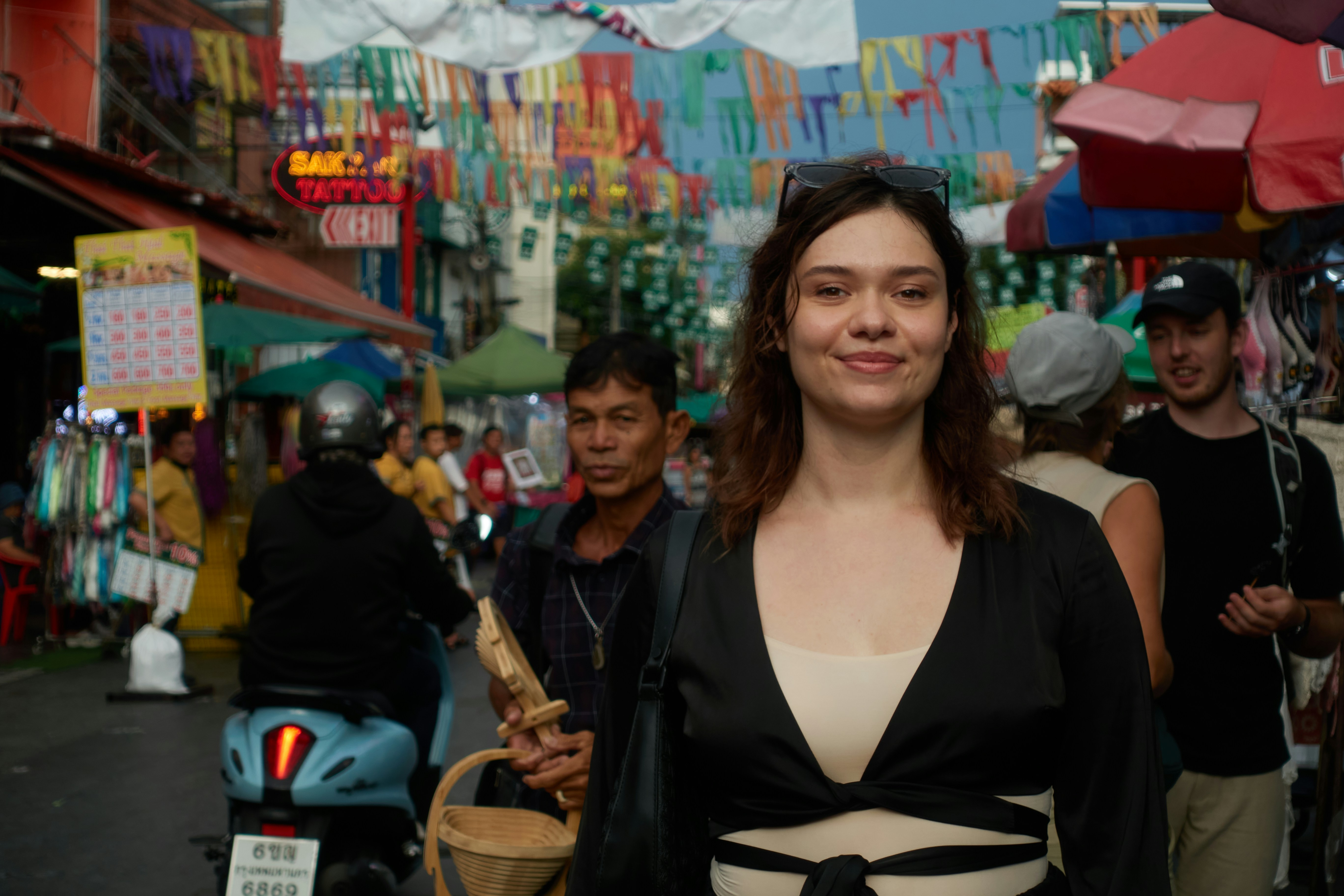 Street Portrait Amid Colorful Festival Banners