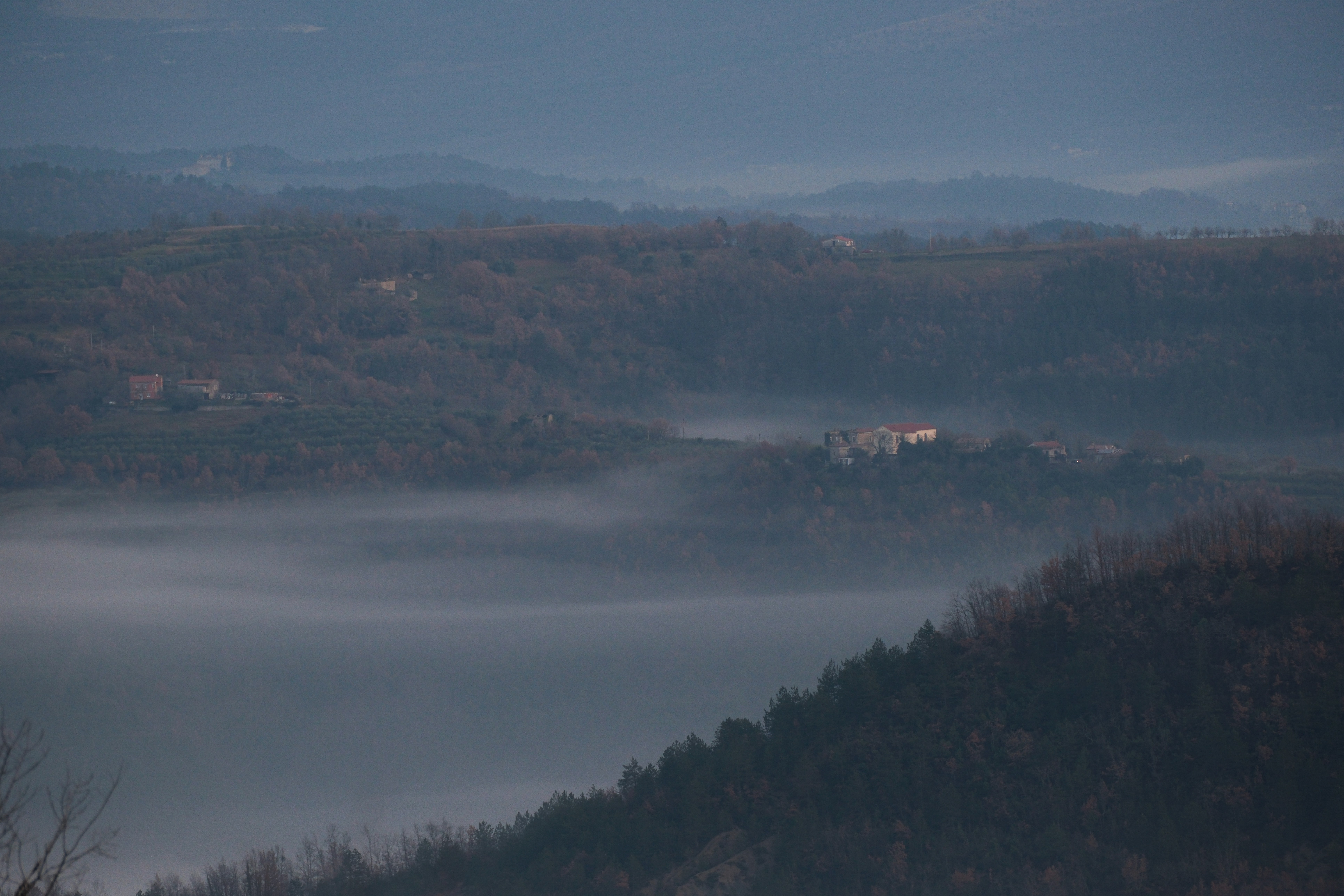Mist-Laced Ridge: A Quiet Dawn Over Valley Fog